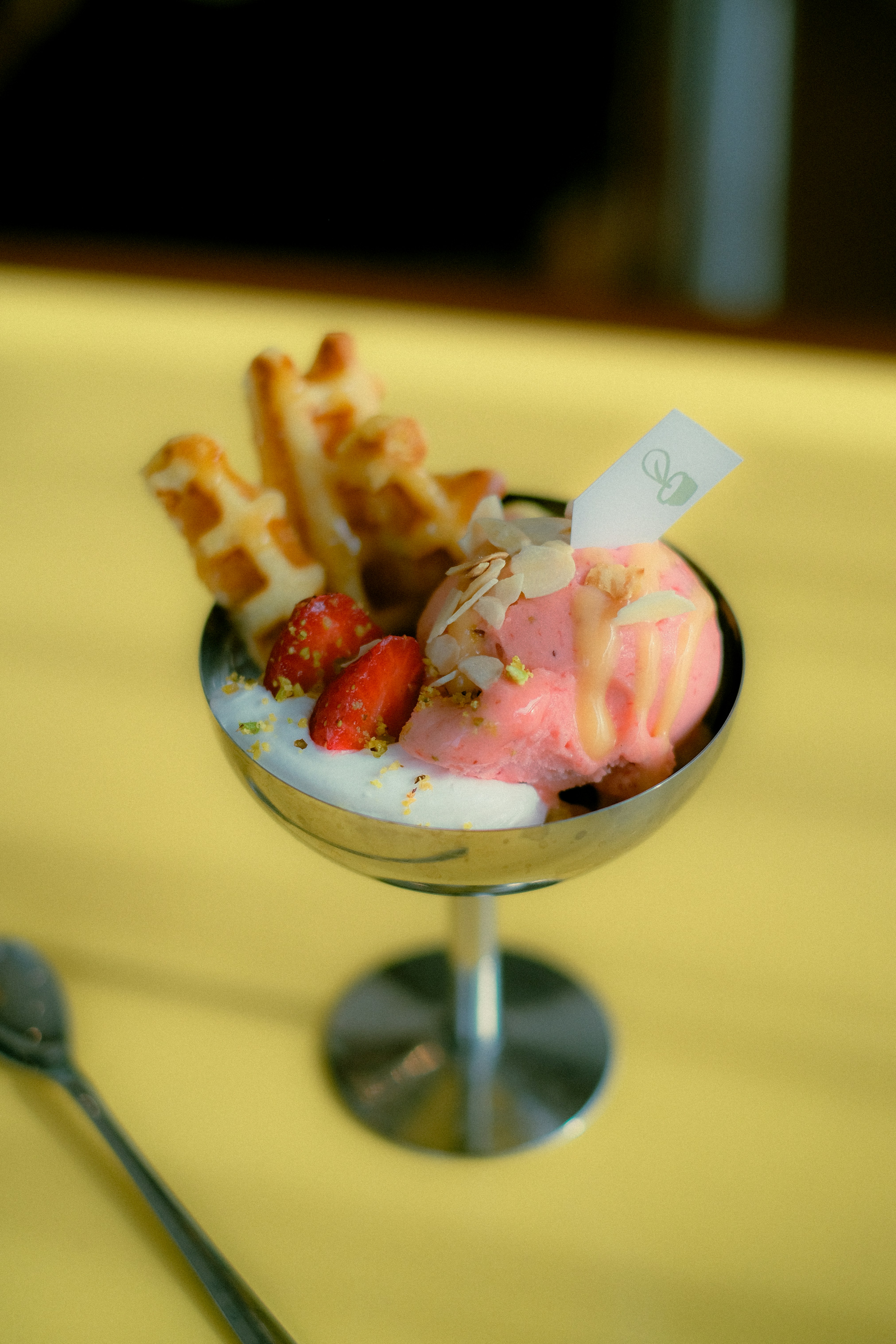 Strawberry ice cream sundae with waffles and fruit.