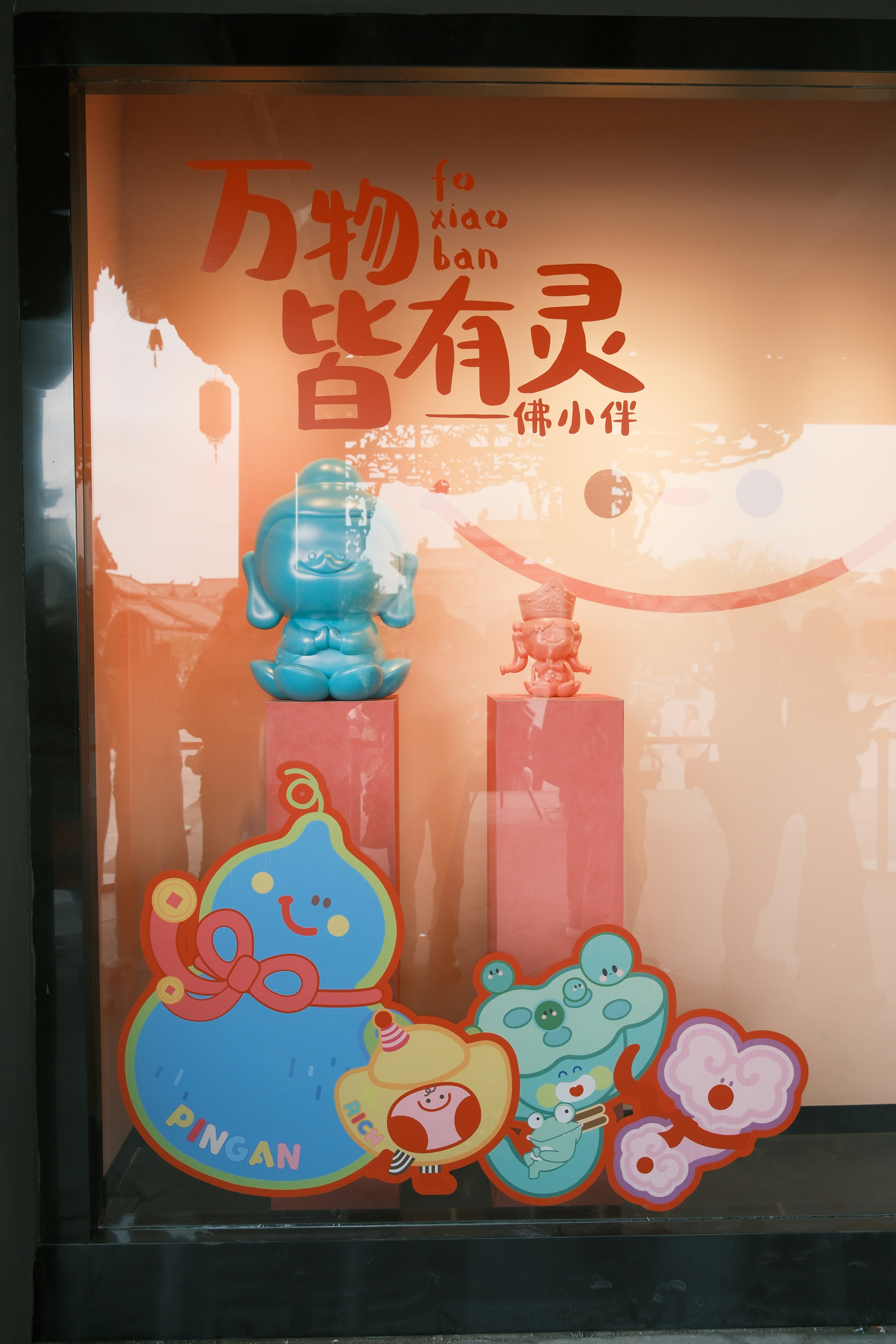 Azure Guardian on a Red Pedestal: A Playful Cartoon Display in a Lantern-Glow Window