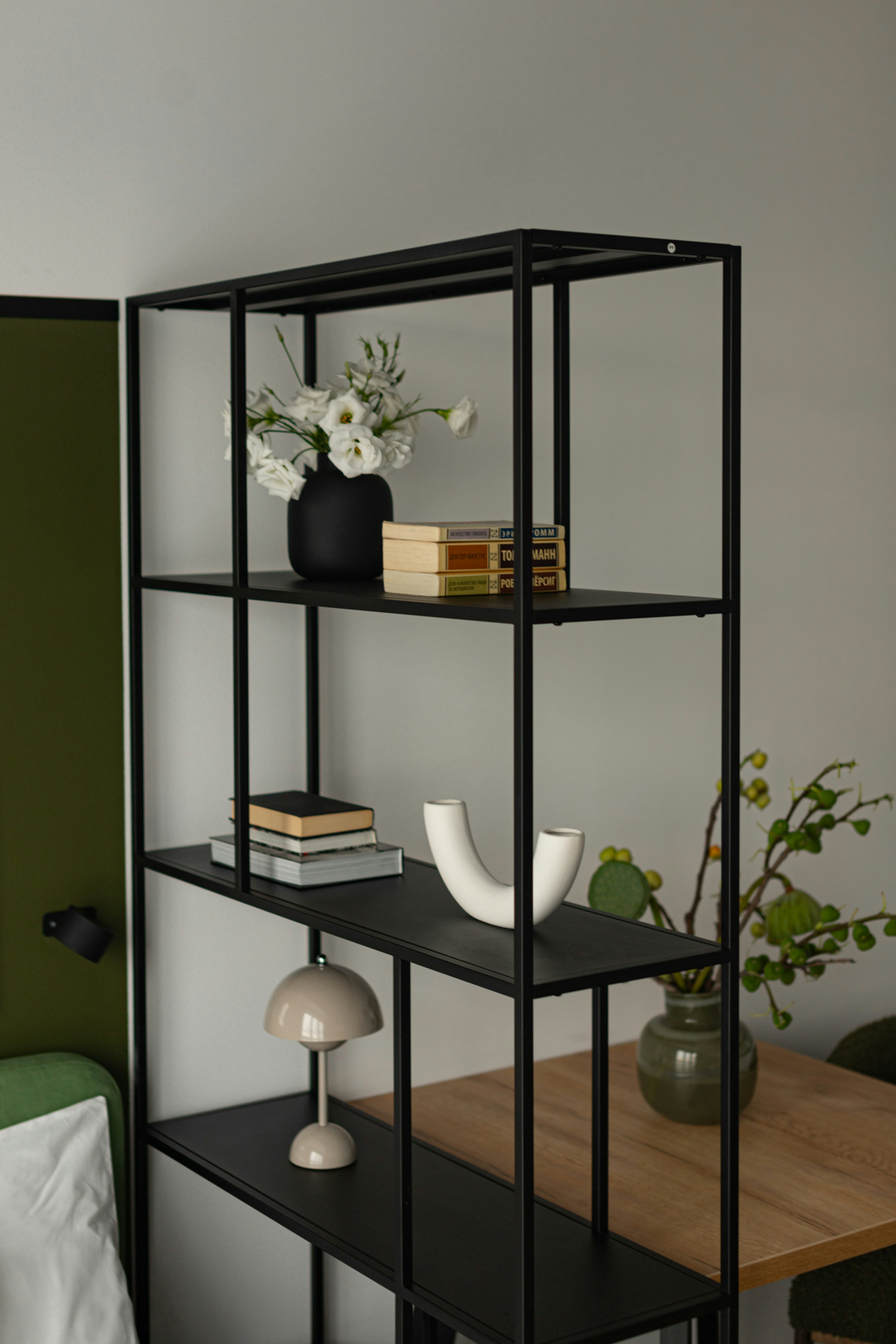 Black shelf unit with decorative items and plants. photo – Free ...