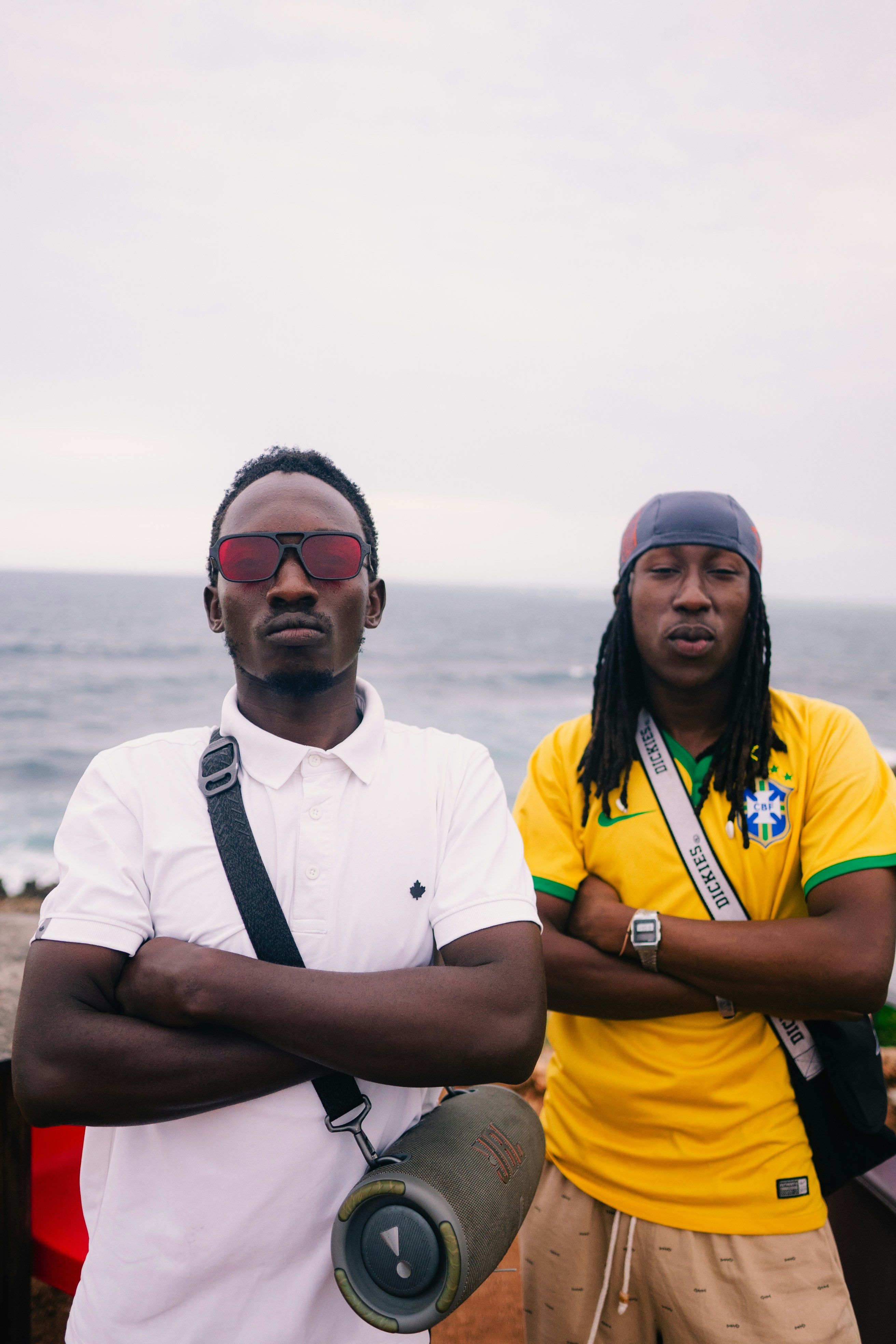 Two men with arms crossed by the ocean. photo – Free Friends Image on ...