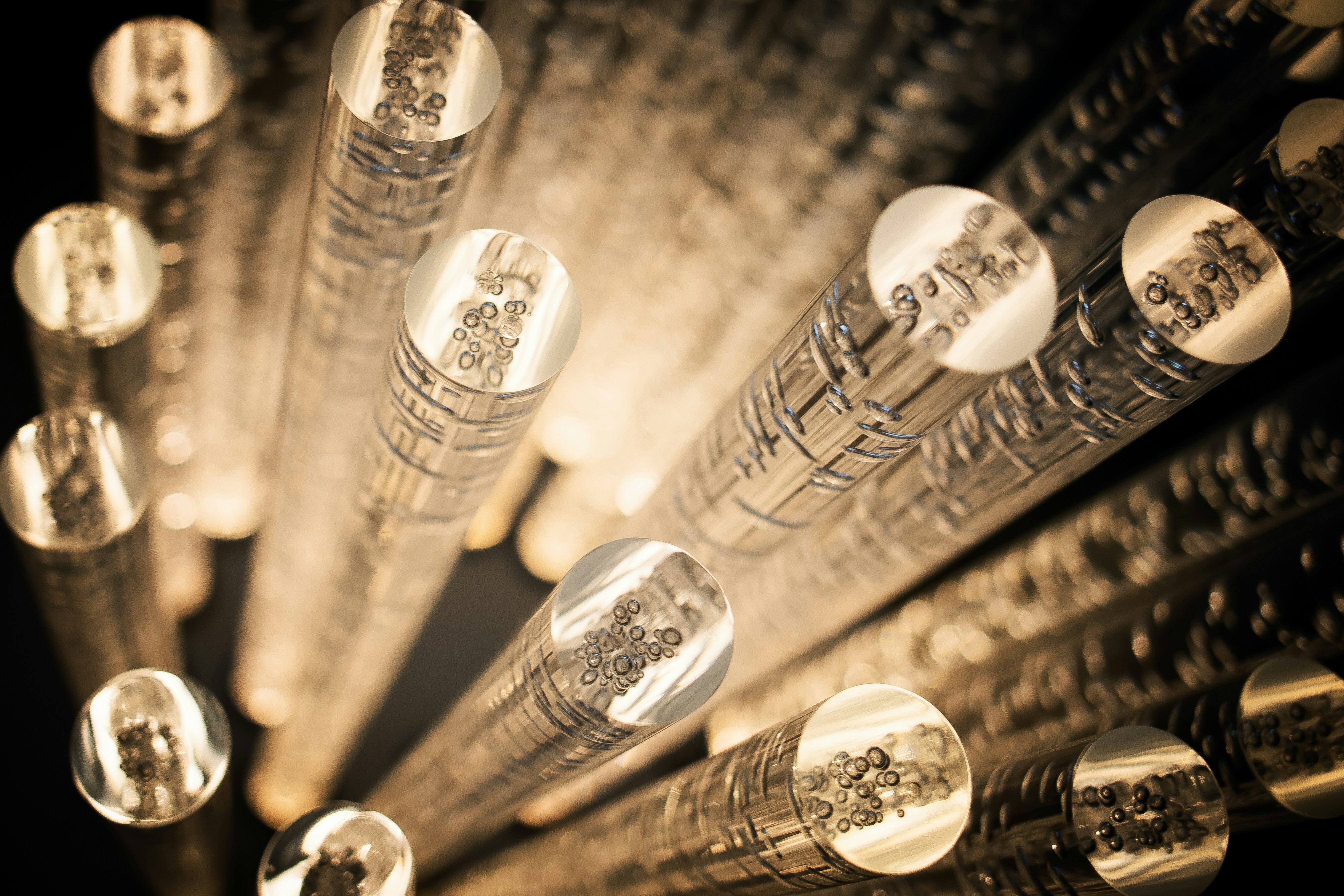 A dynamic arrangement of illuminated glass tubes radiating light, creating a mesmerizing visual effect.