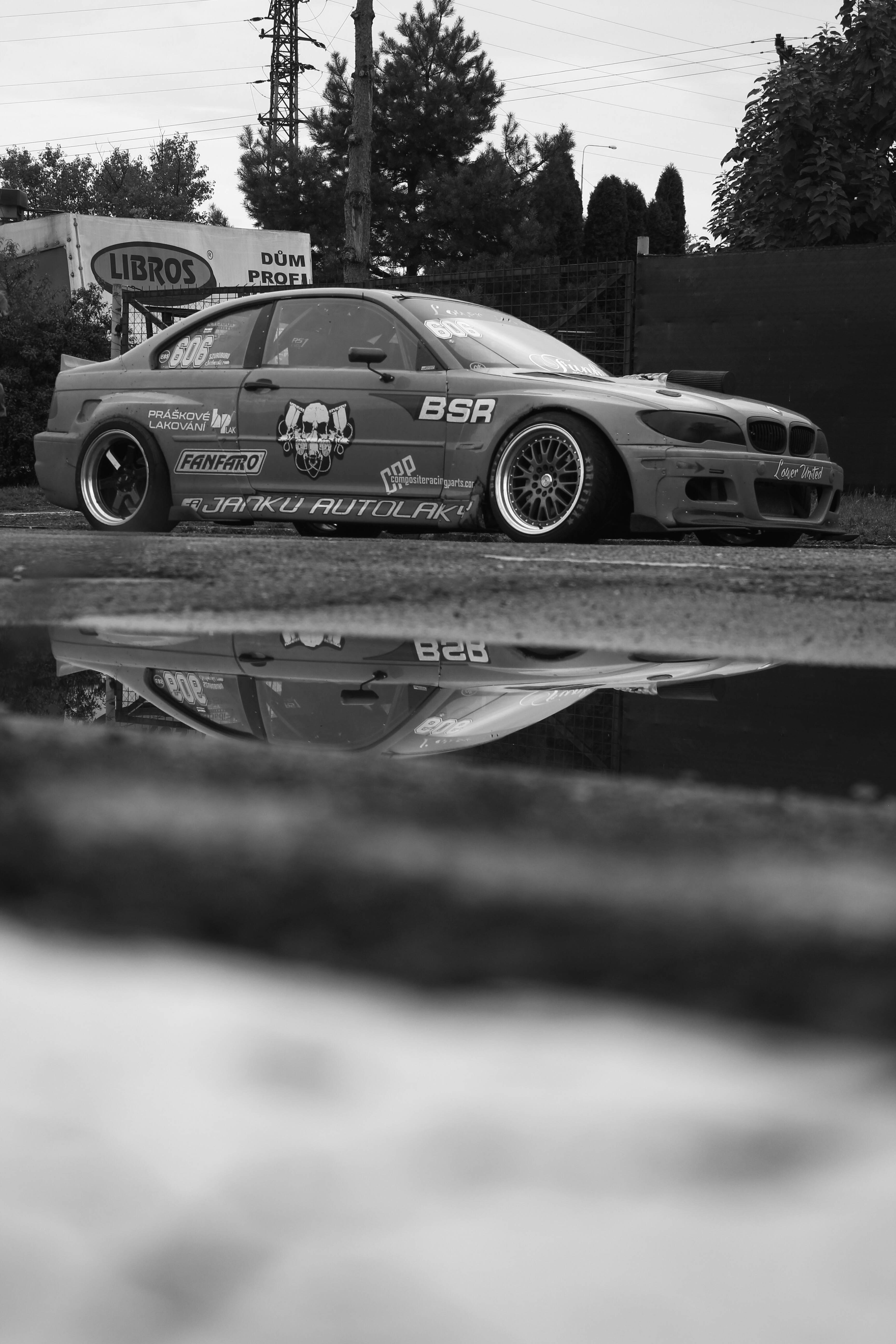 Little break from work? buymeacoffee.com/davidlembas | Modified sports car reflected in a puddle.