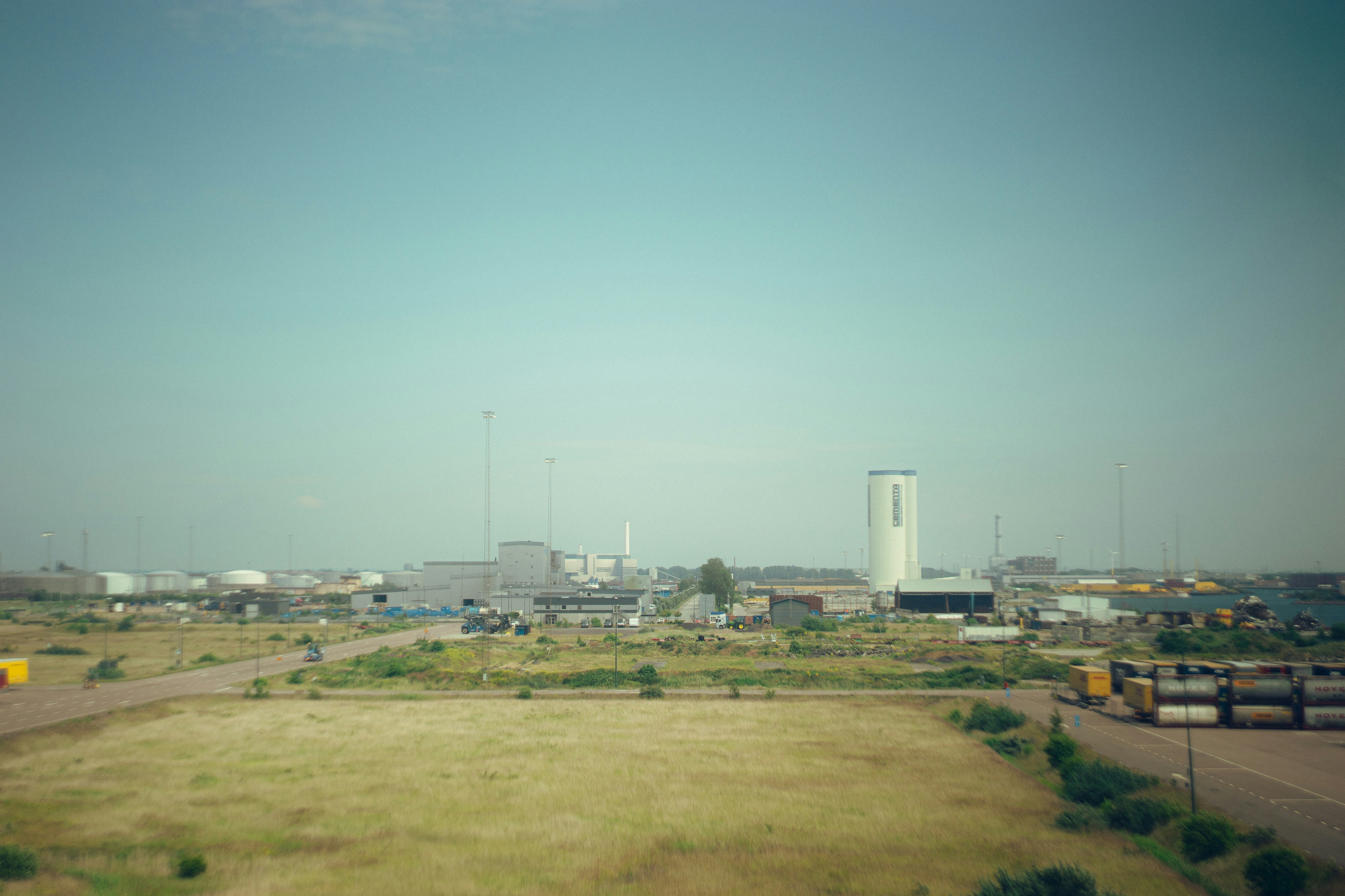 Industrial complex with tall tower under clear sky