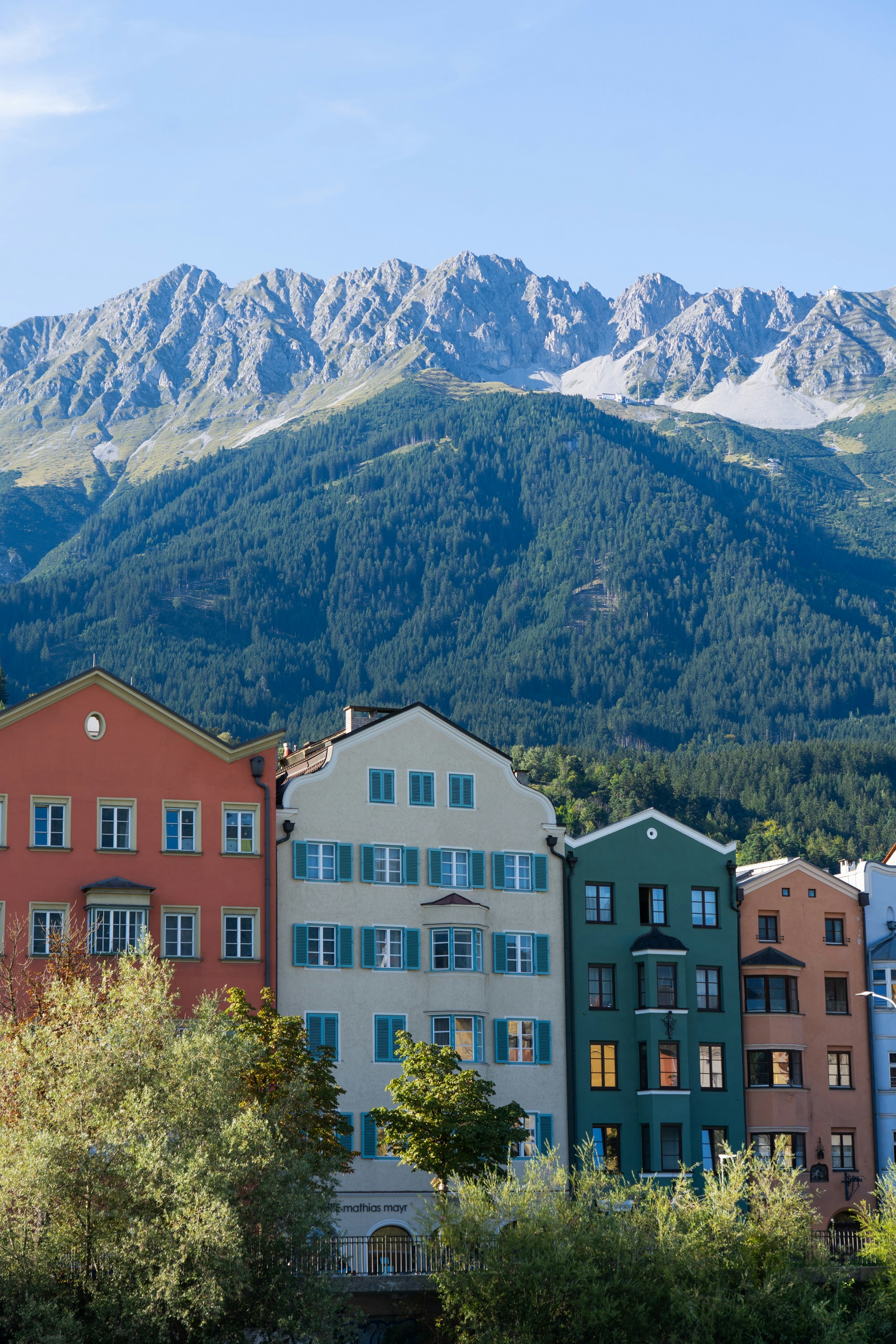 Colorful buildings in front of a mountain range.