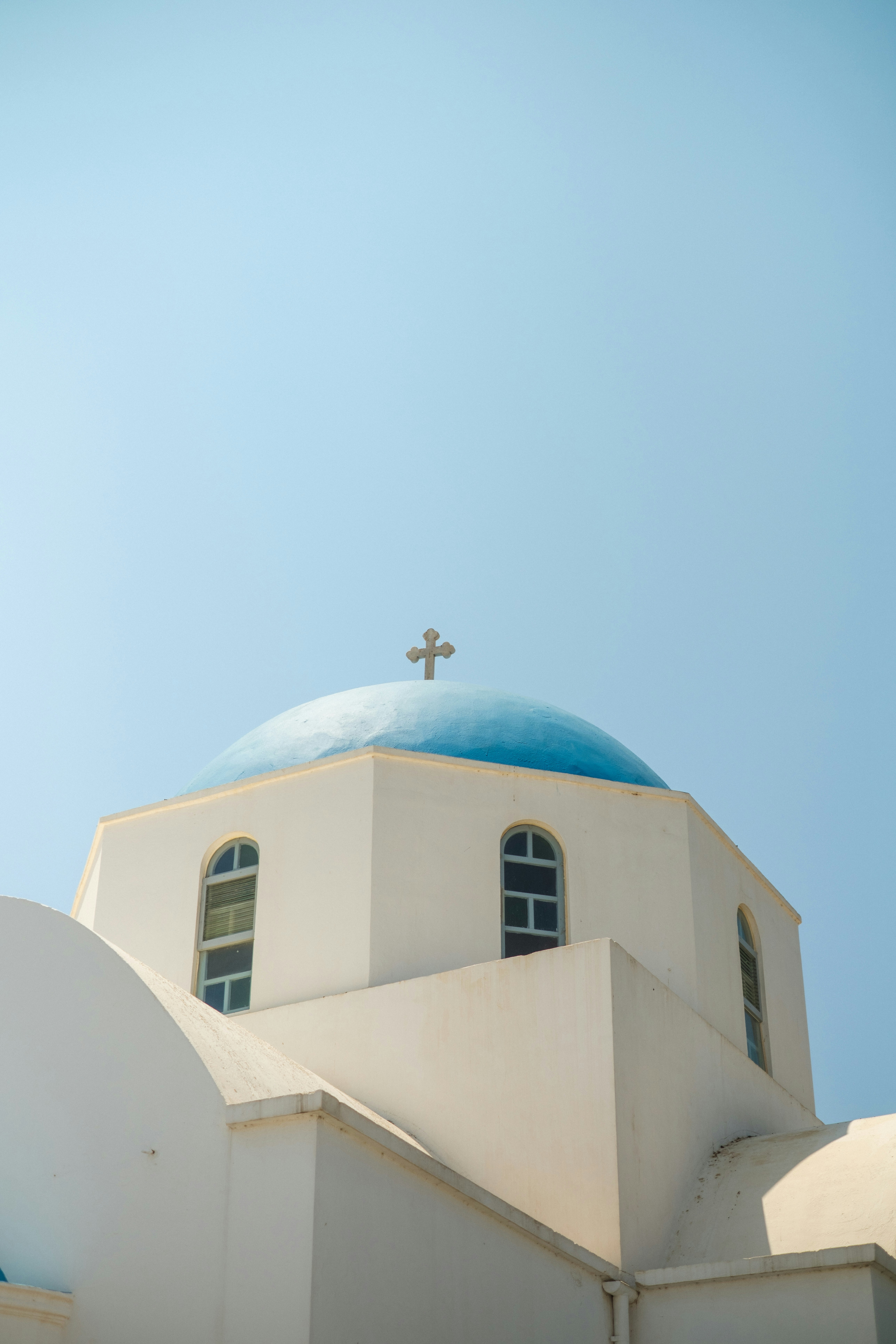 Traditional Greek Church in Paros, Greece. | White church with blue dome under clear sky