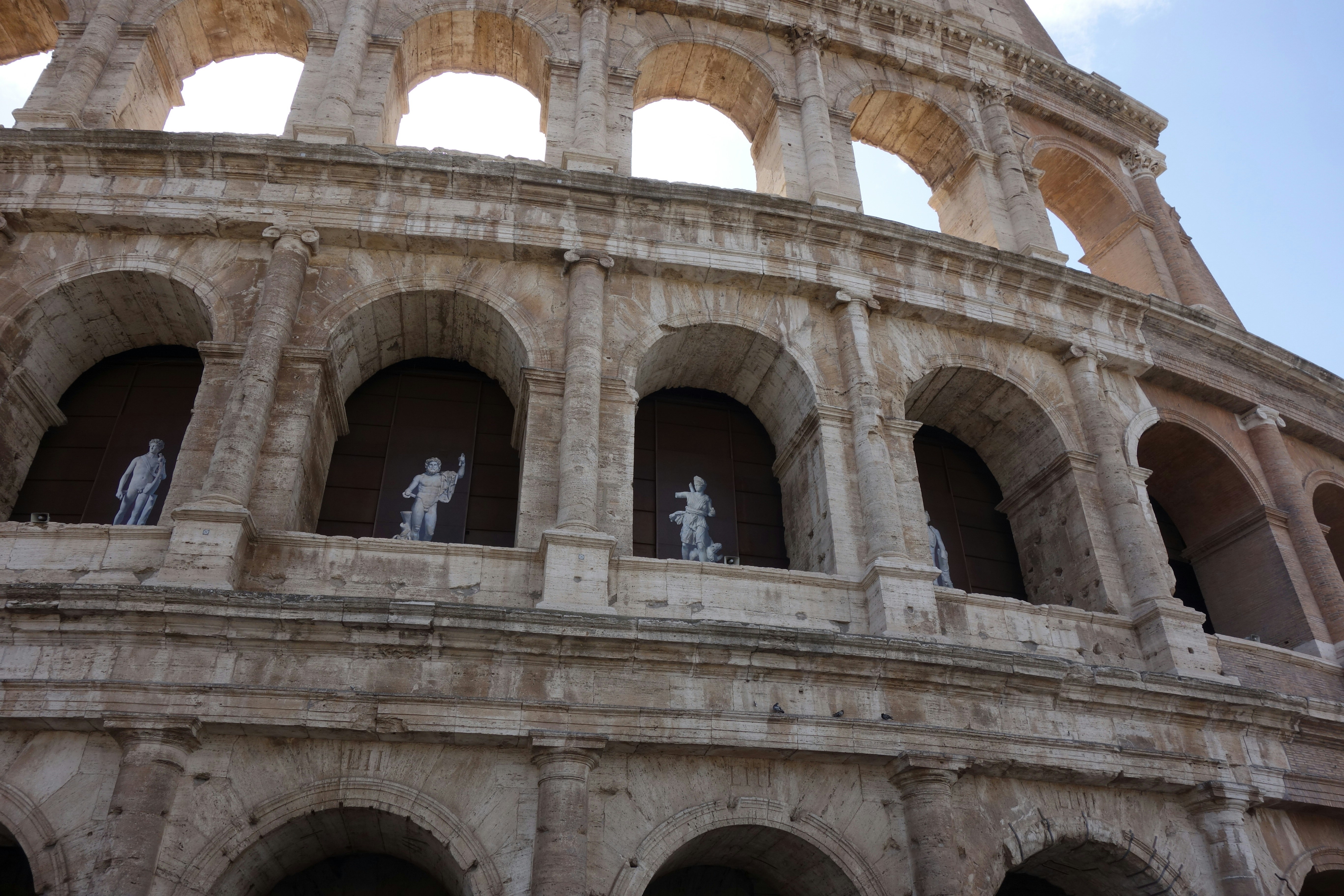 Close-up of the colosseum in rome with statues. photo – Free Image on ...
