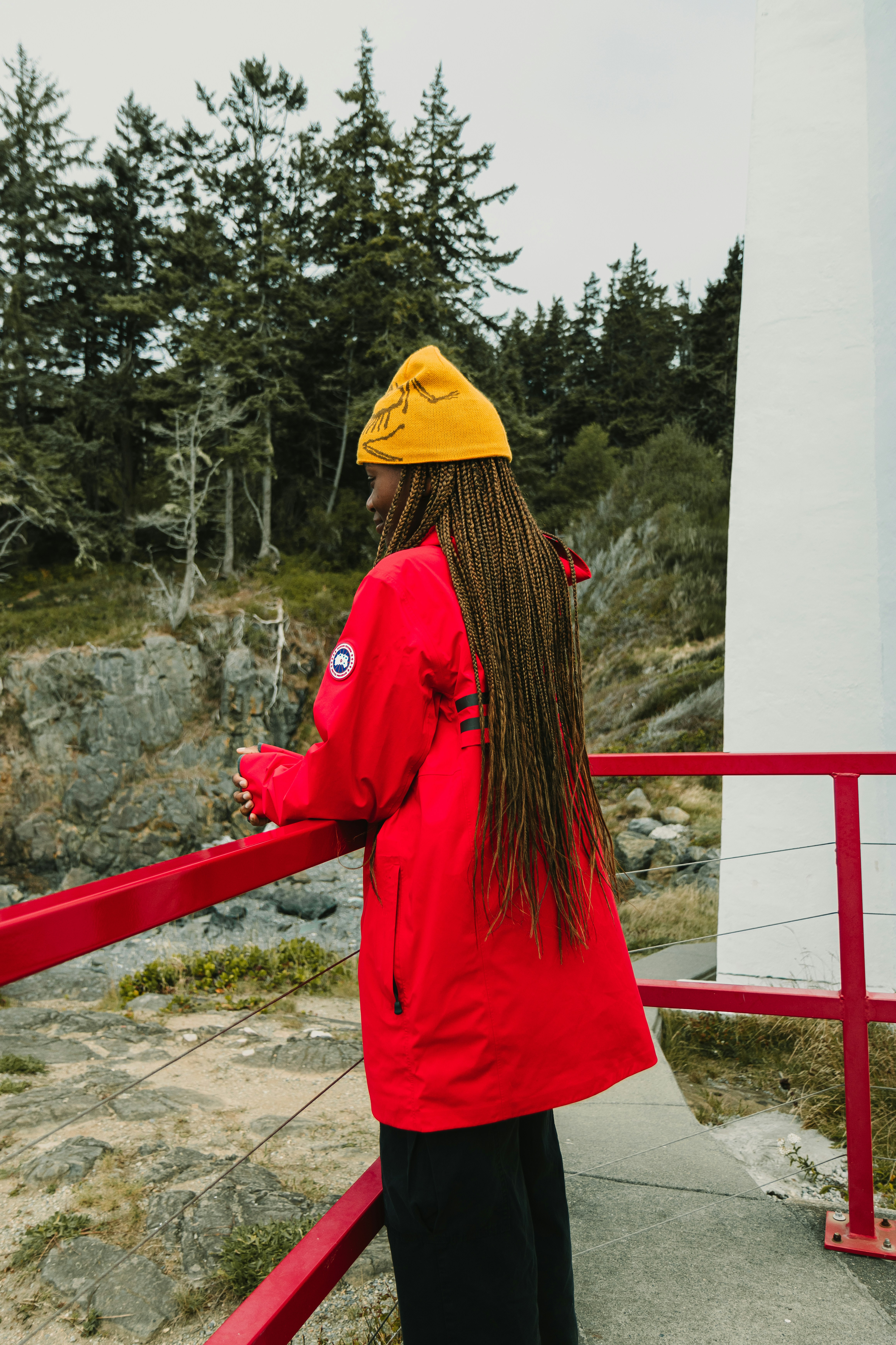 Red Jacket at the Edge: A Portrait on a Coastal Walkway