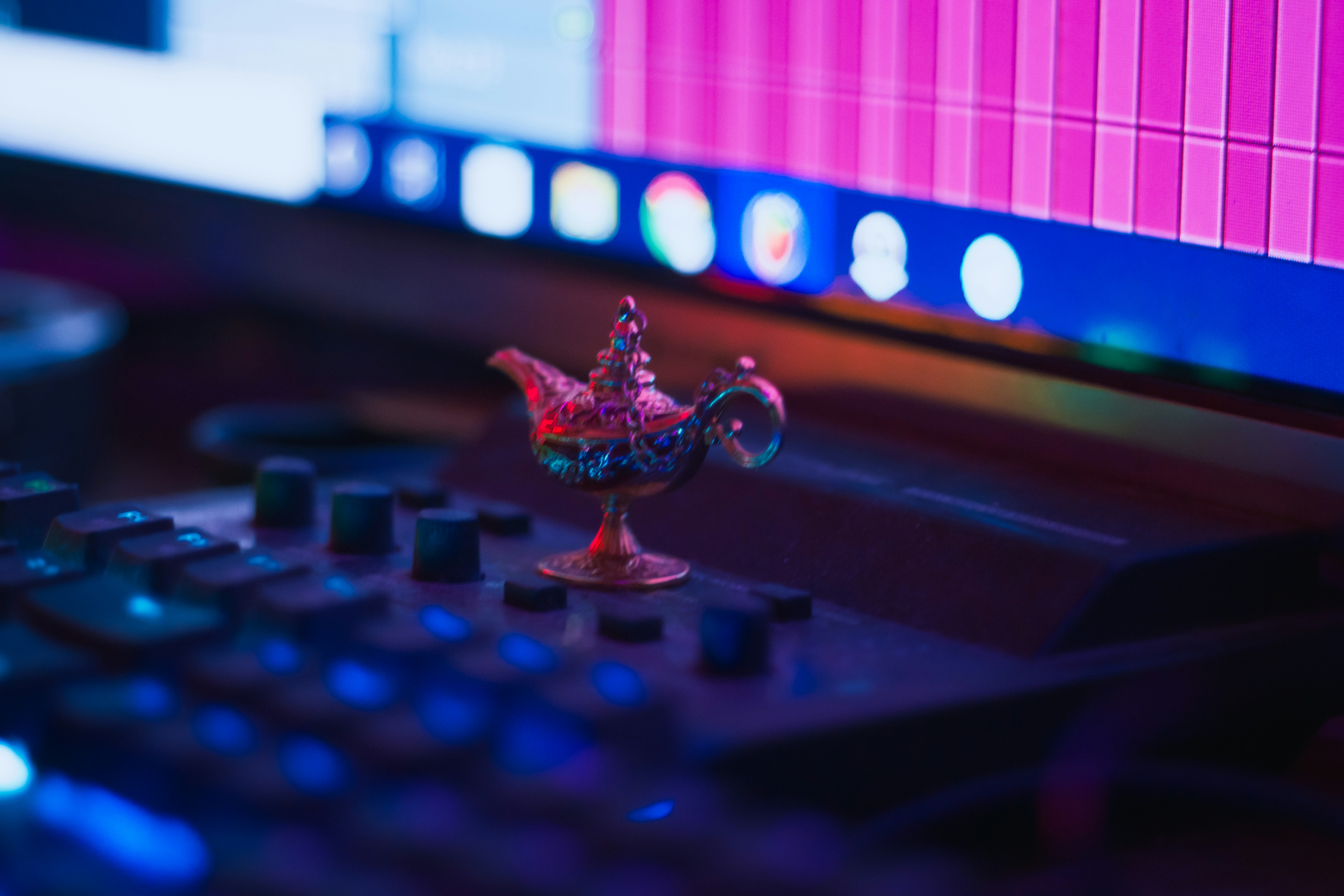 A miniature genie lamp sits on a keyboard.