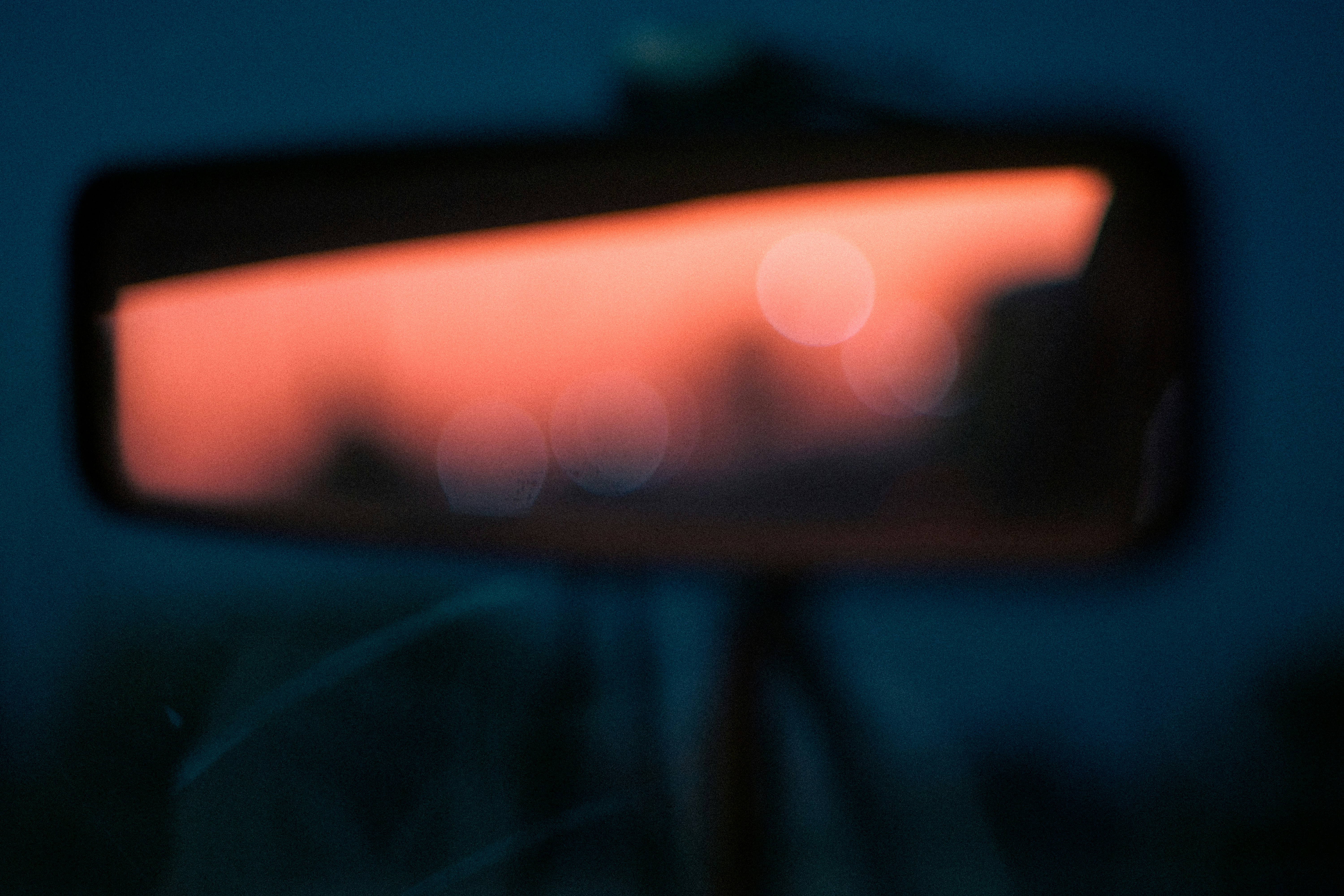 Sunset reflected in a car's rearview mirror