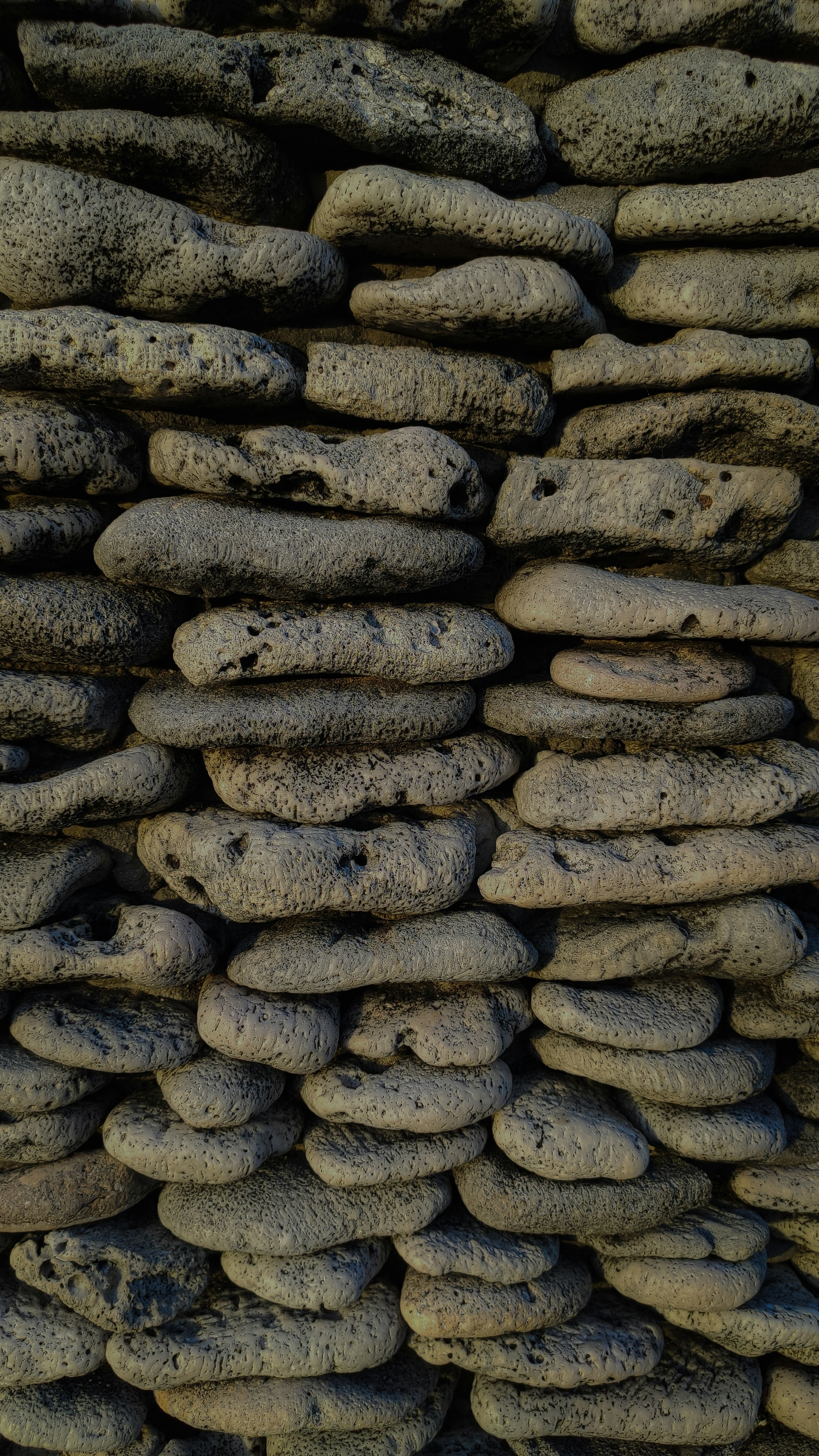 Stacked grey stones forming a textured wall