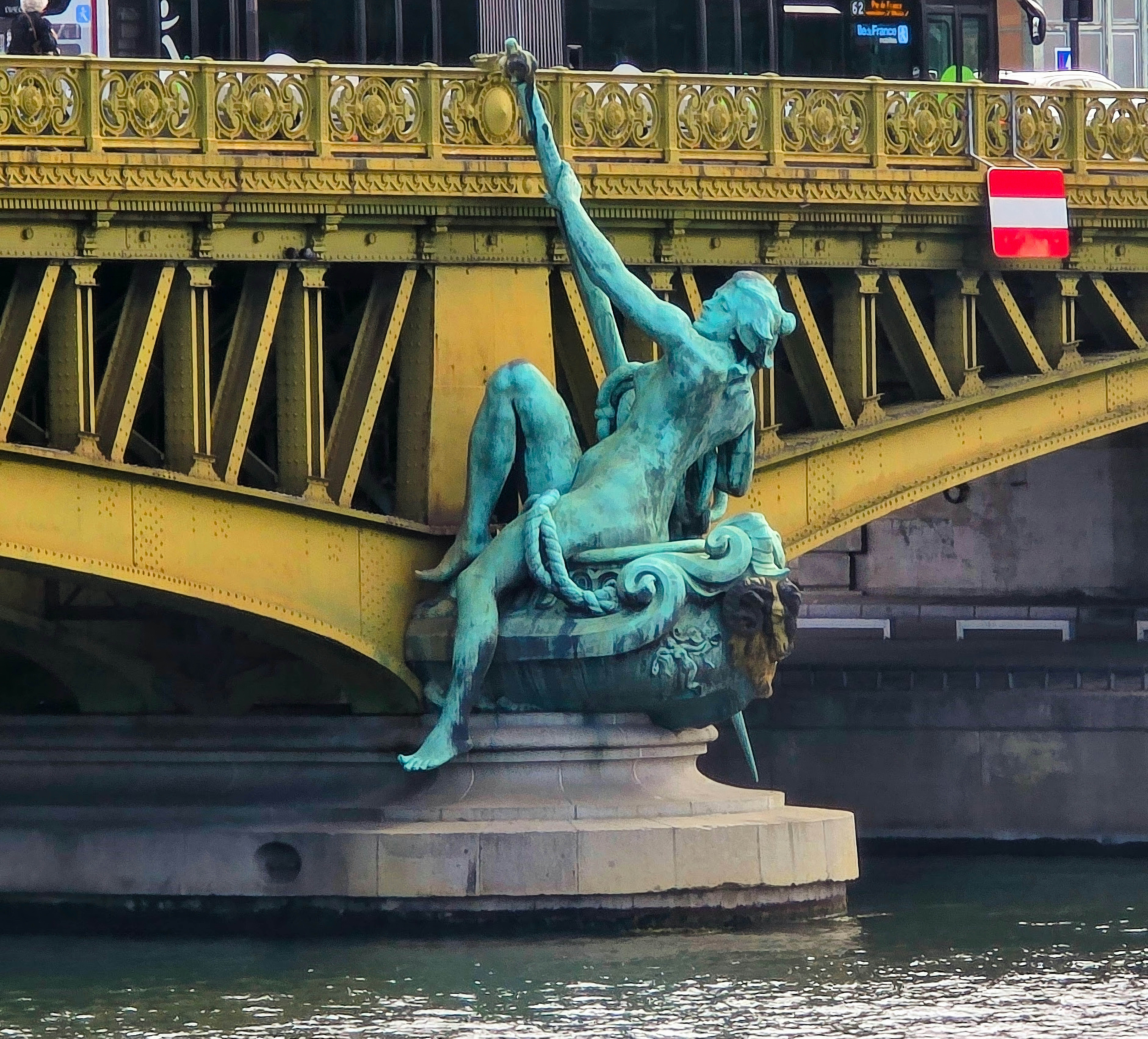 Bronze statue of a figure on a bridge support. photo – Free ...