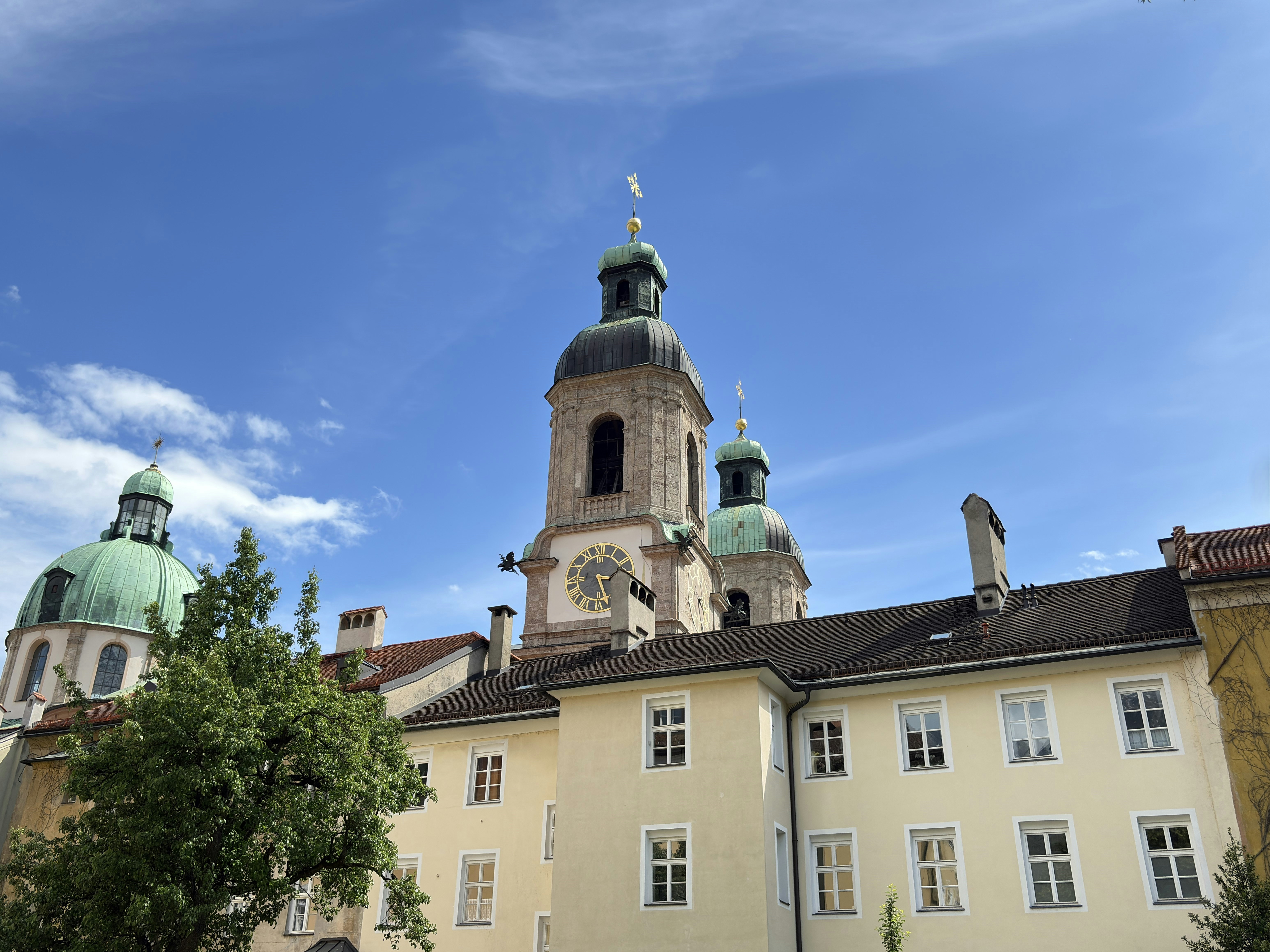 Innsbruck Cathedral, also known as Dom St. Jakob or the Cathedral of St. James, in Innsbruck, Austria | Historic church with green domes and clock tower.