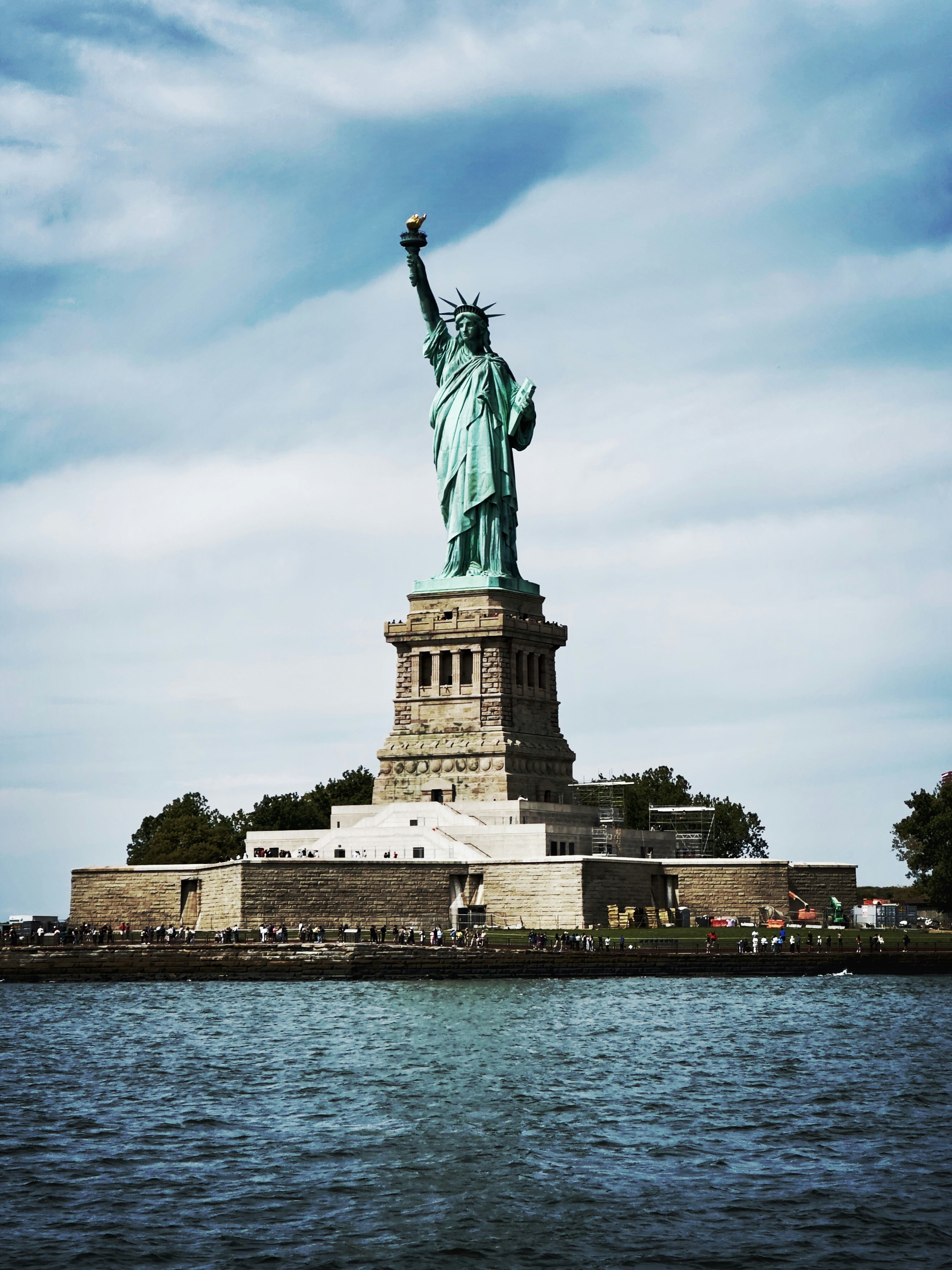 Statue of Liberty | The statue of liberty stands tall against a cloudy sky.