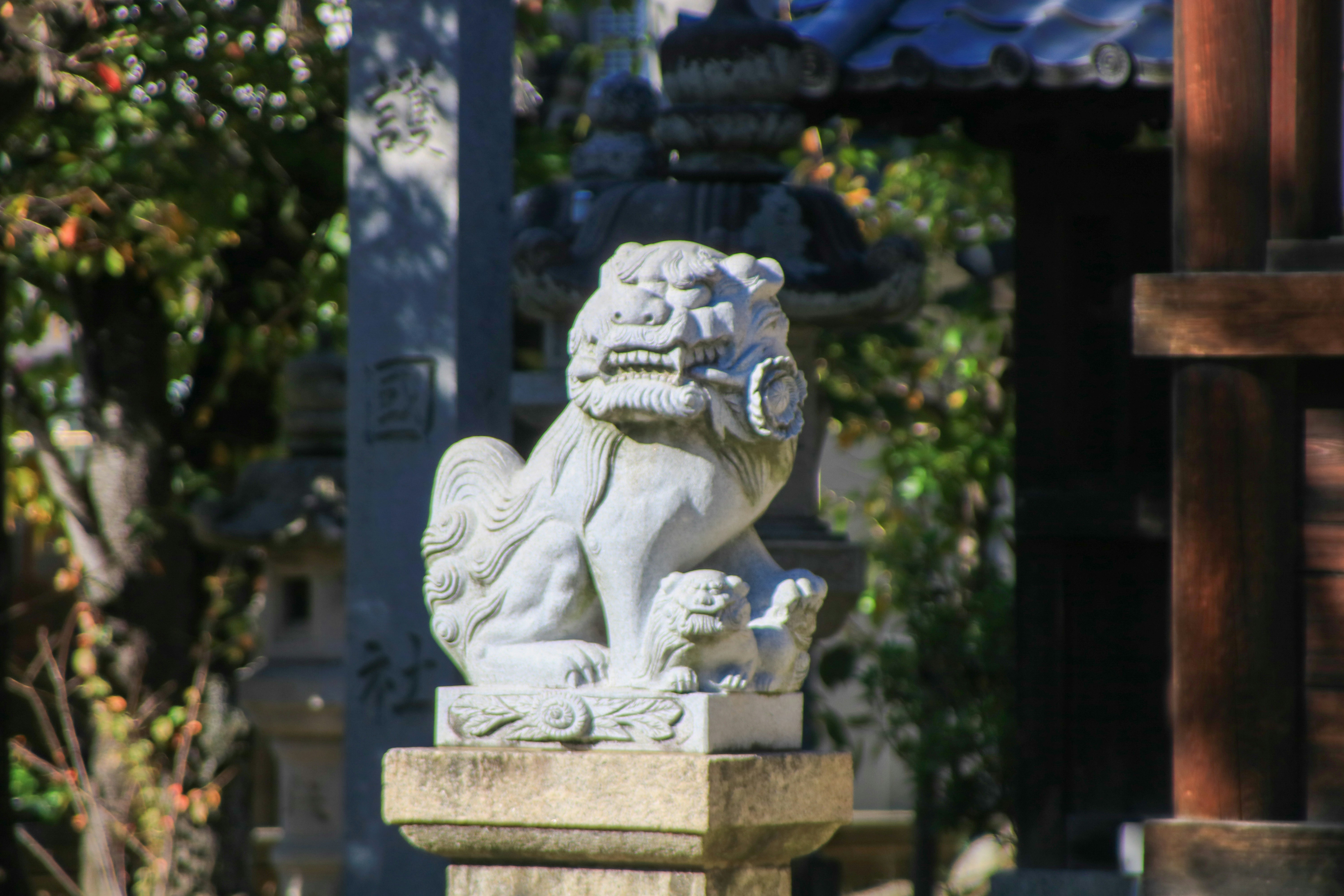 Stone lion statue guarding a shrine entrance