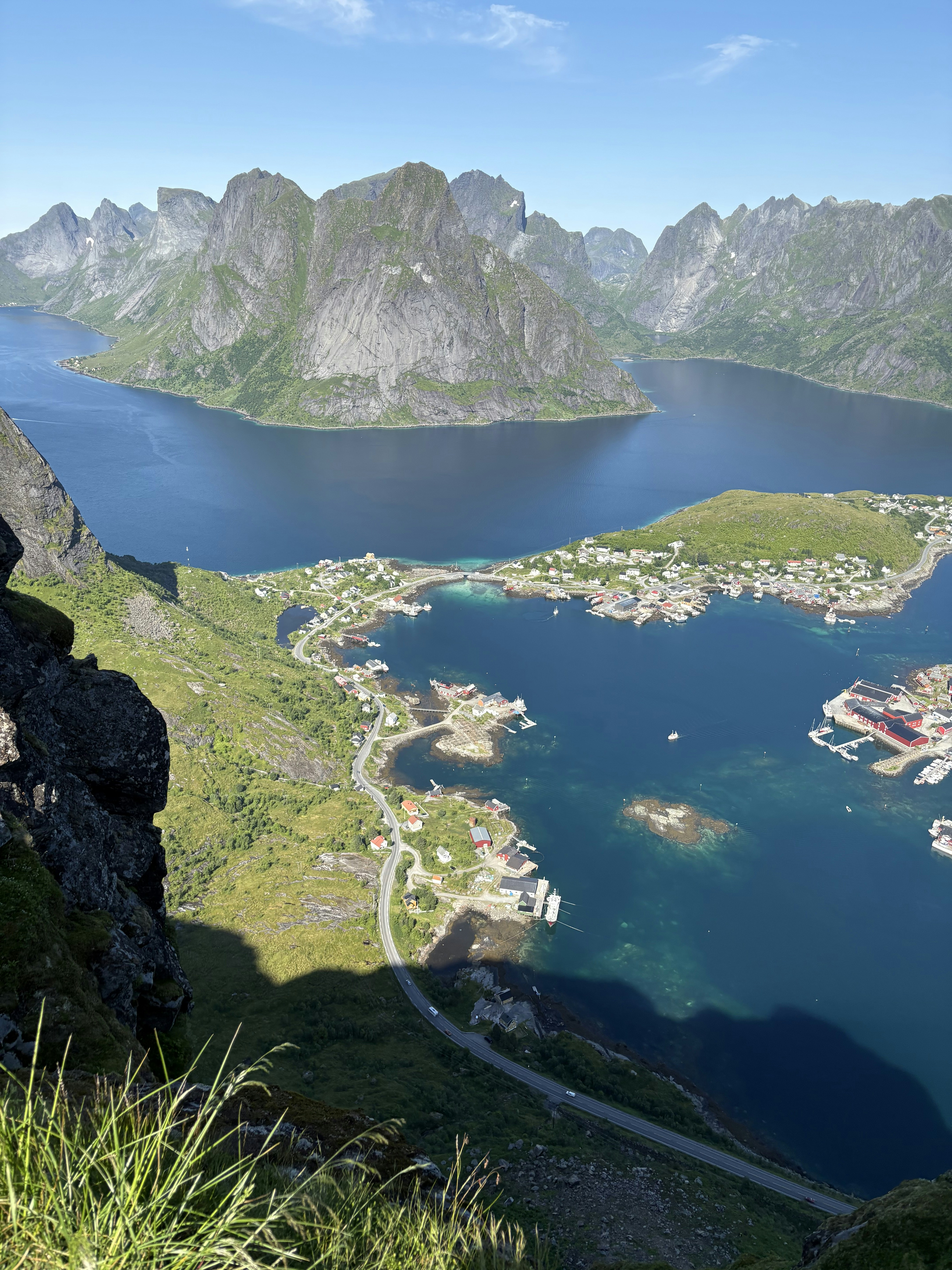 Coastal village nestled between mountains and blue water.