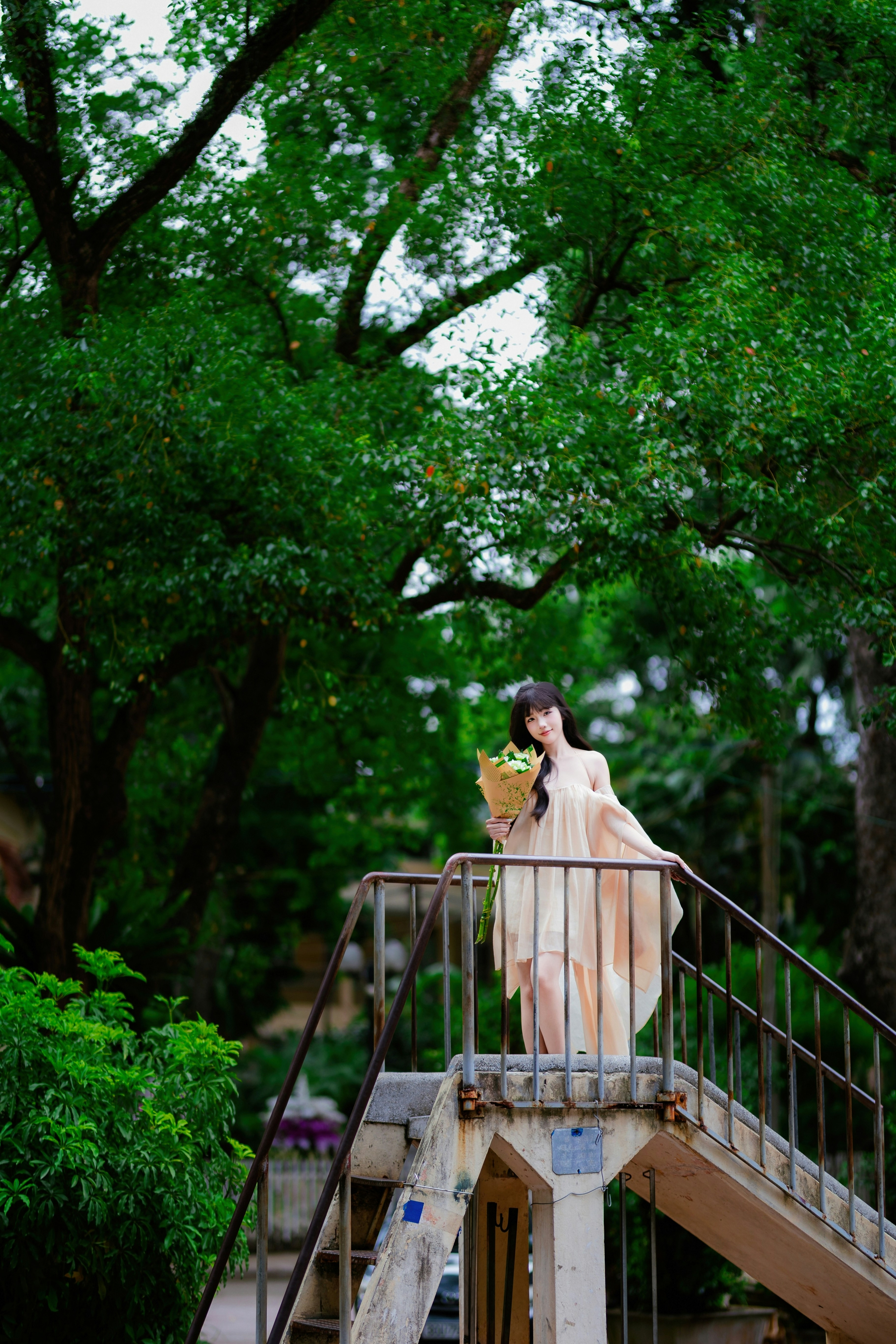 Garden Staircase Serenade: A Pale-Gowned Moment Among Green Canopies