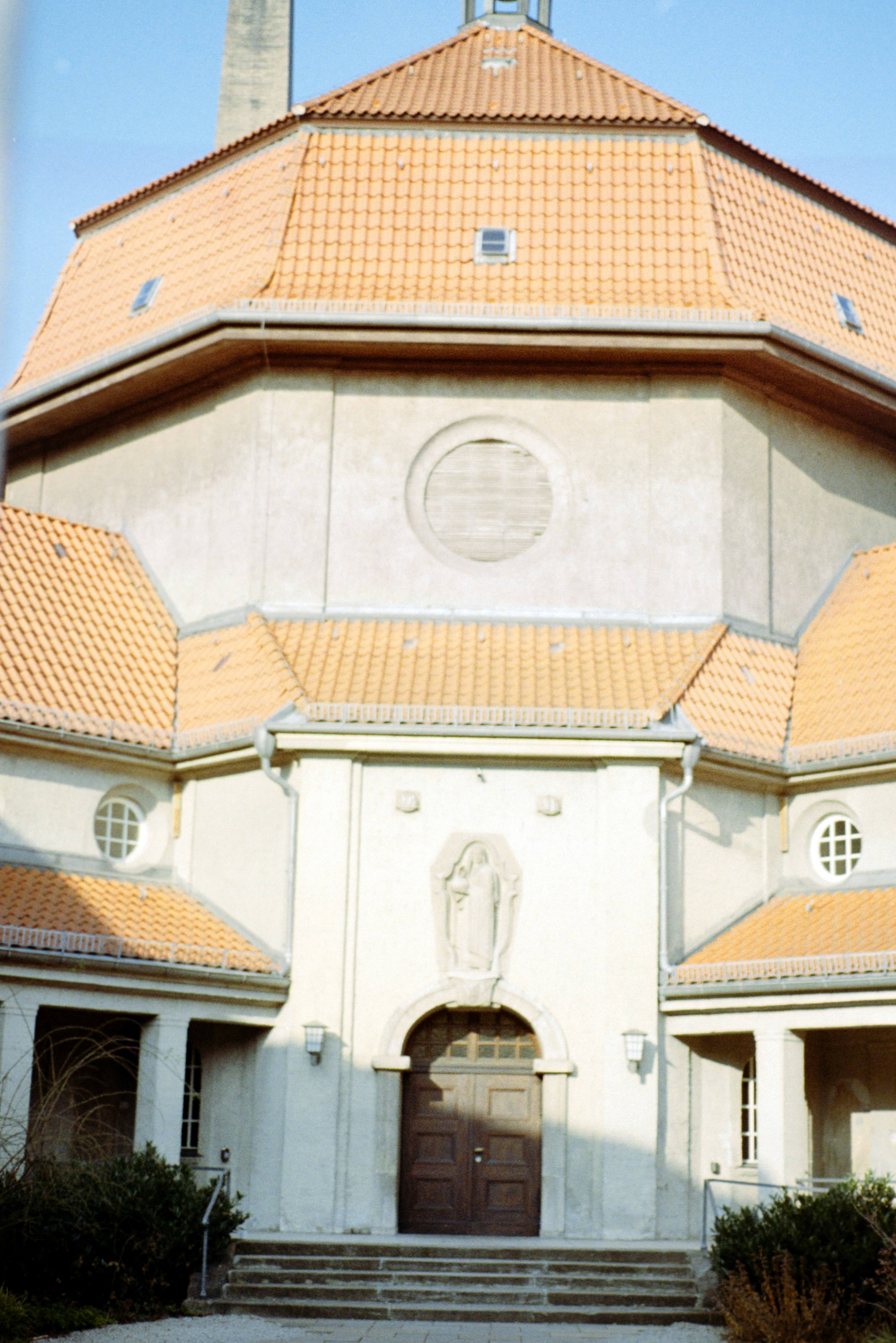 Octagonal church entrance with orange tiled roof