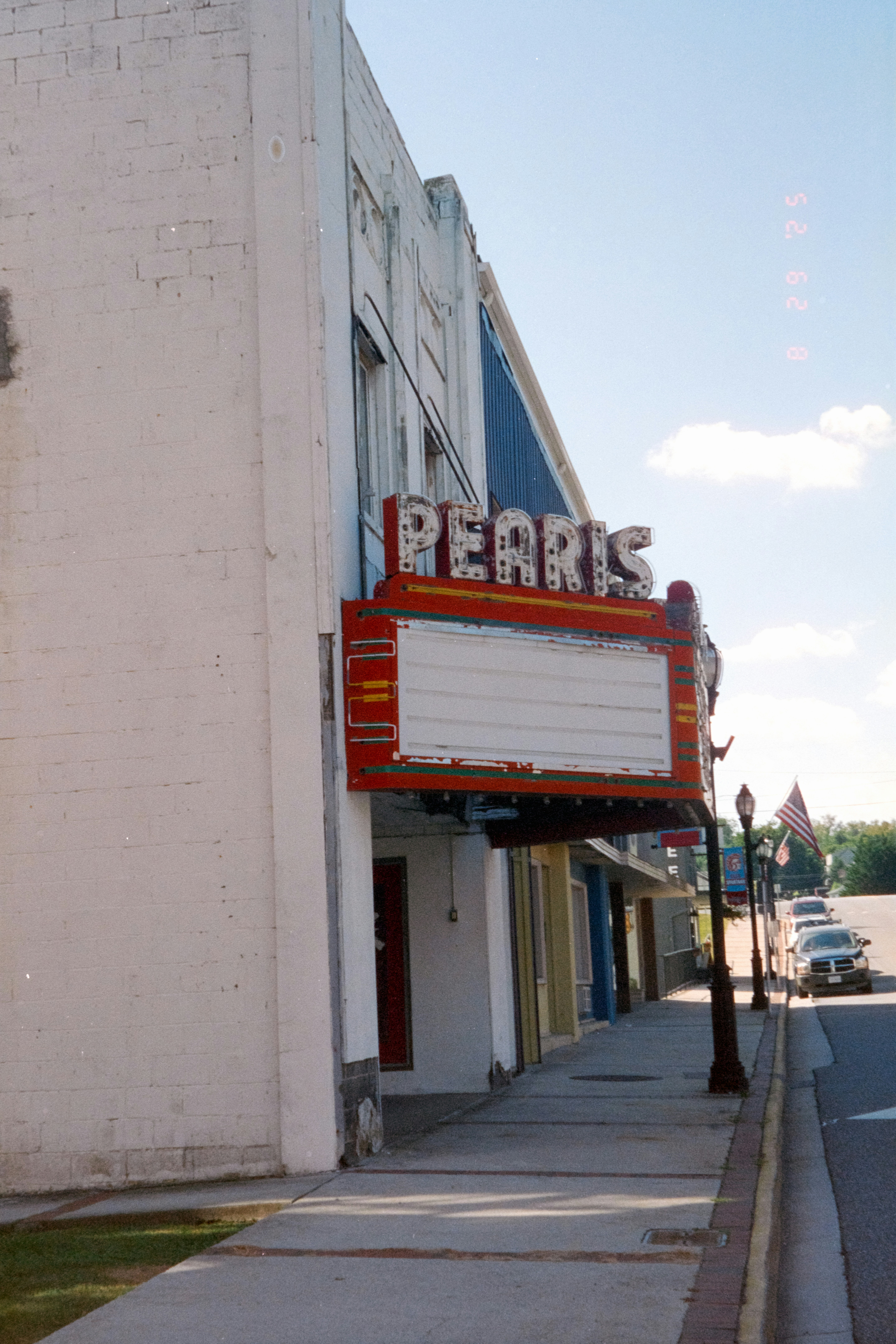 Exterior of the "pearls" theater with a marquee.