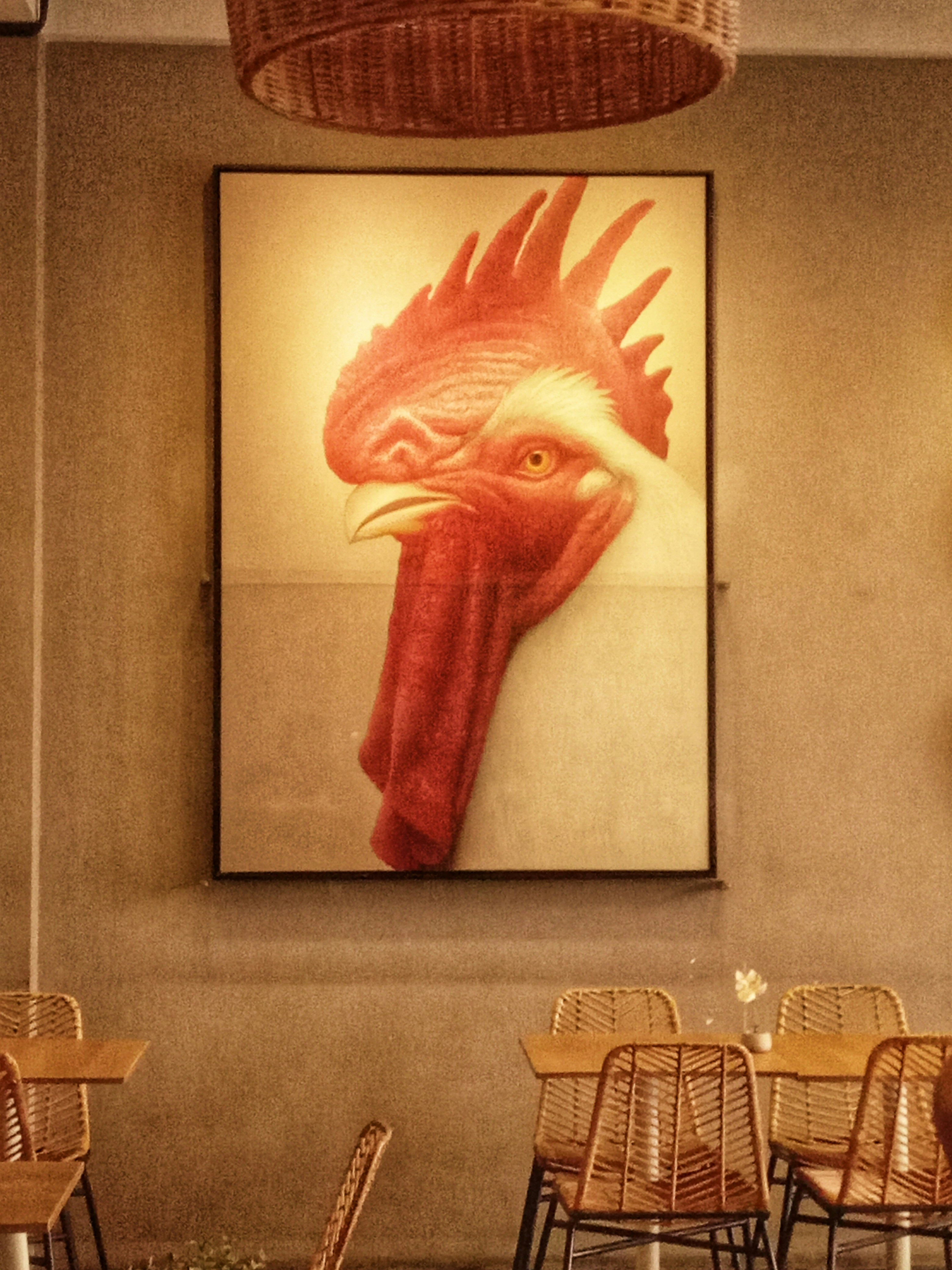 Painting of a rooster's head on a wall