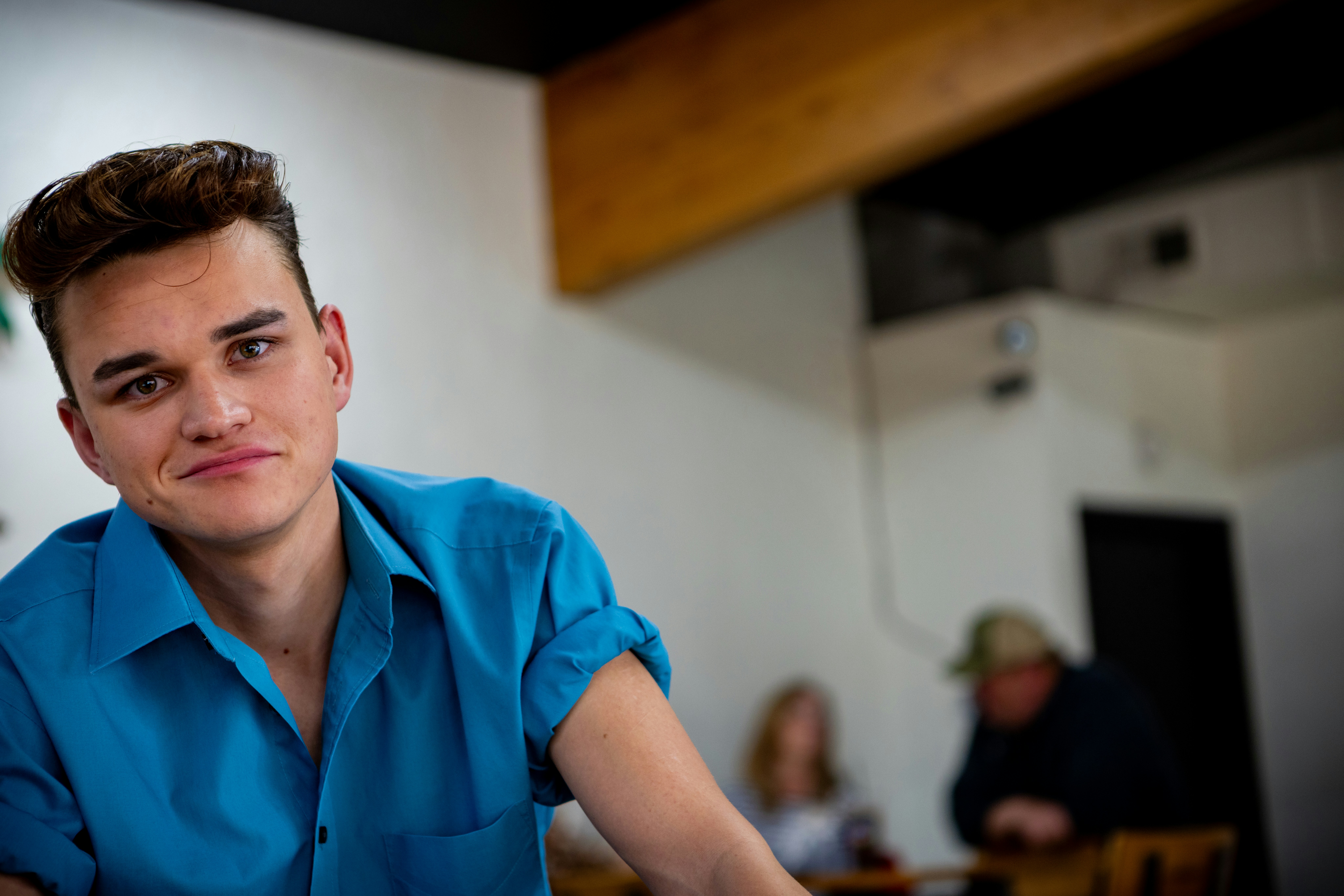 Azure Presence: A Quiet Portrait Framed by a Soft-Blurred Room