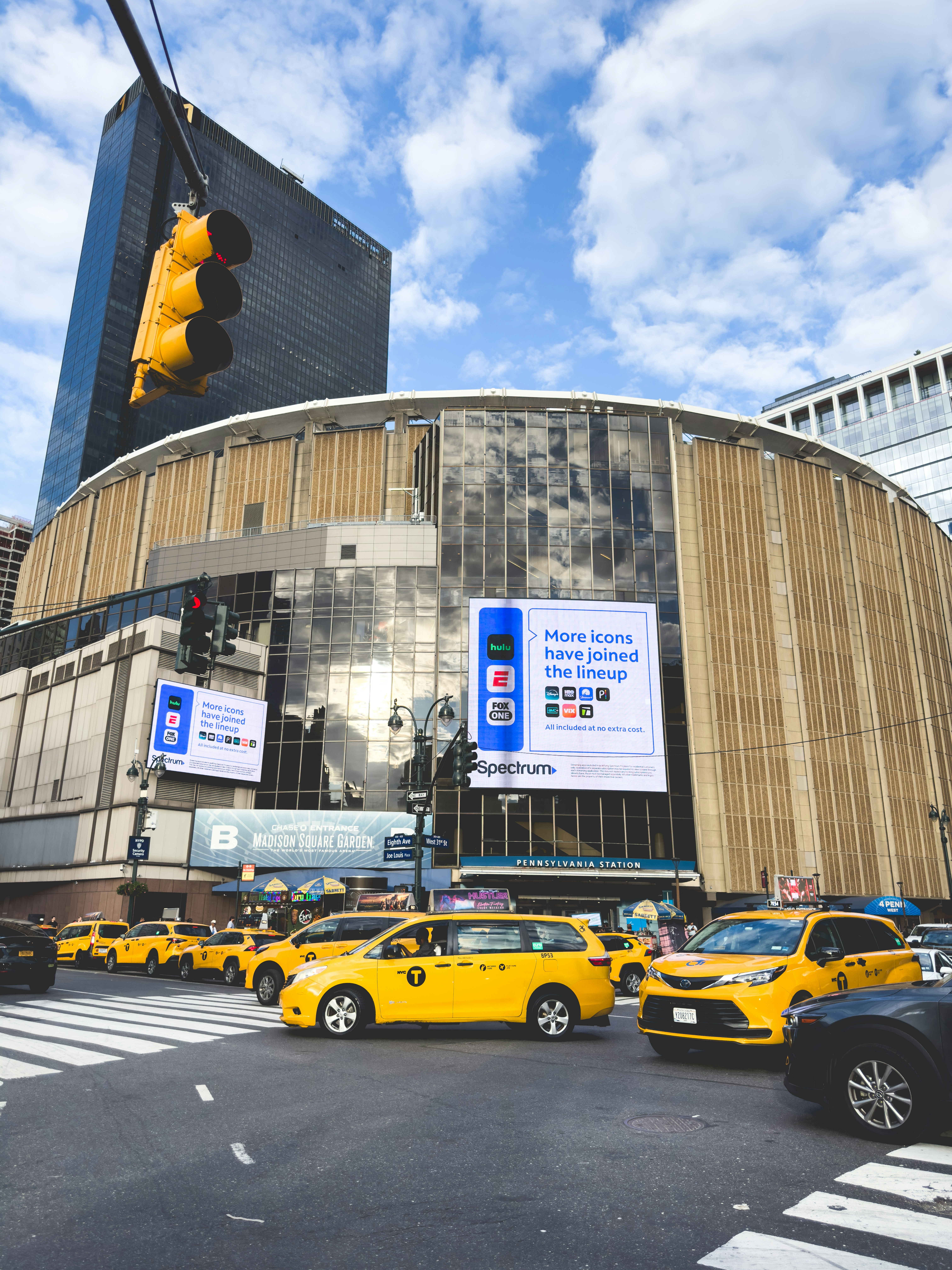 Yellow cabs on a city street near madison square garden.