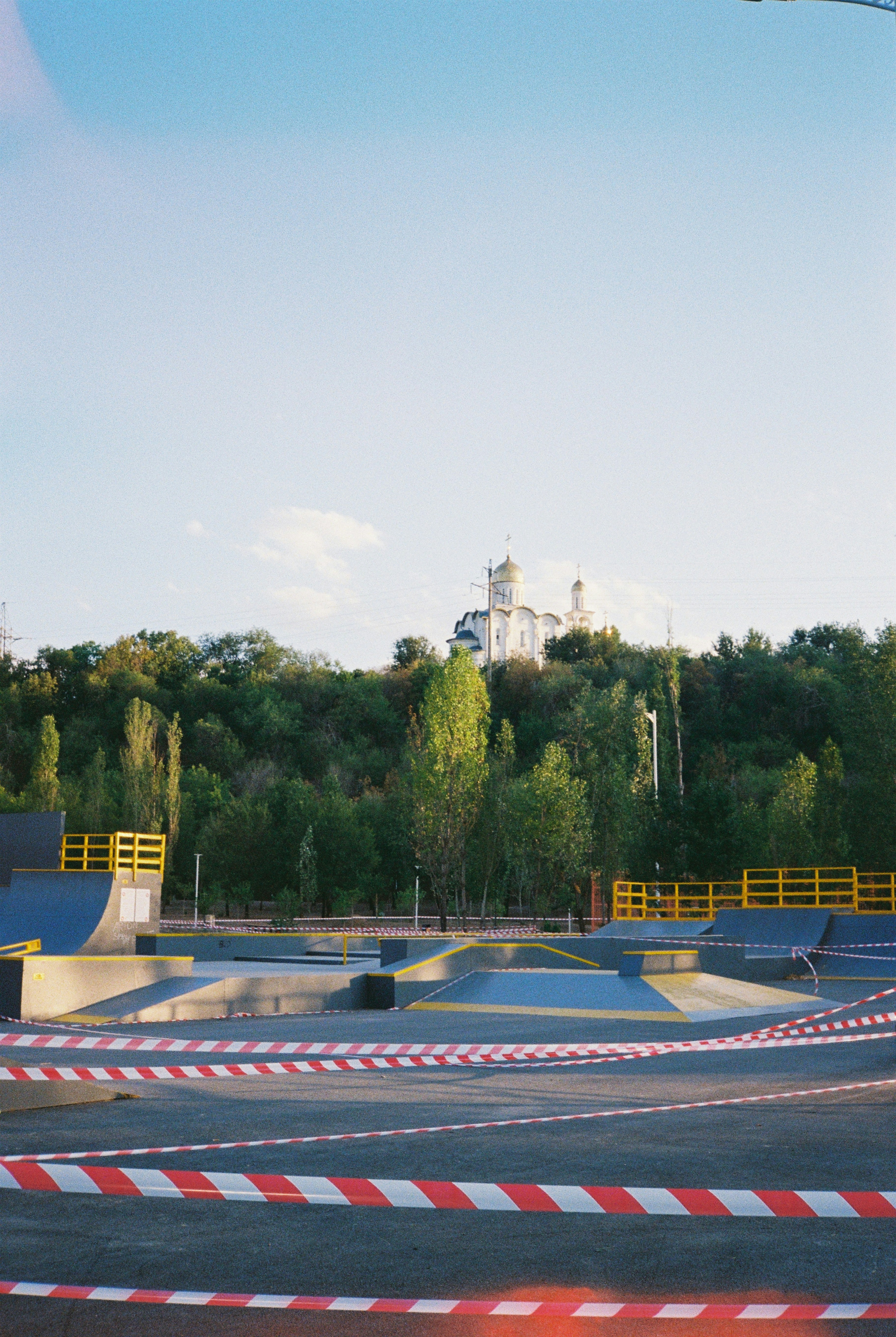 Empty skate park with red and white caution tape.