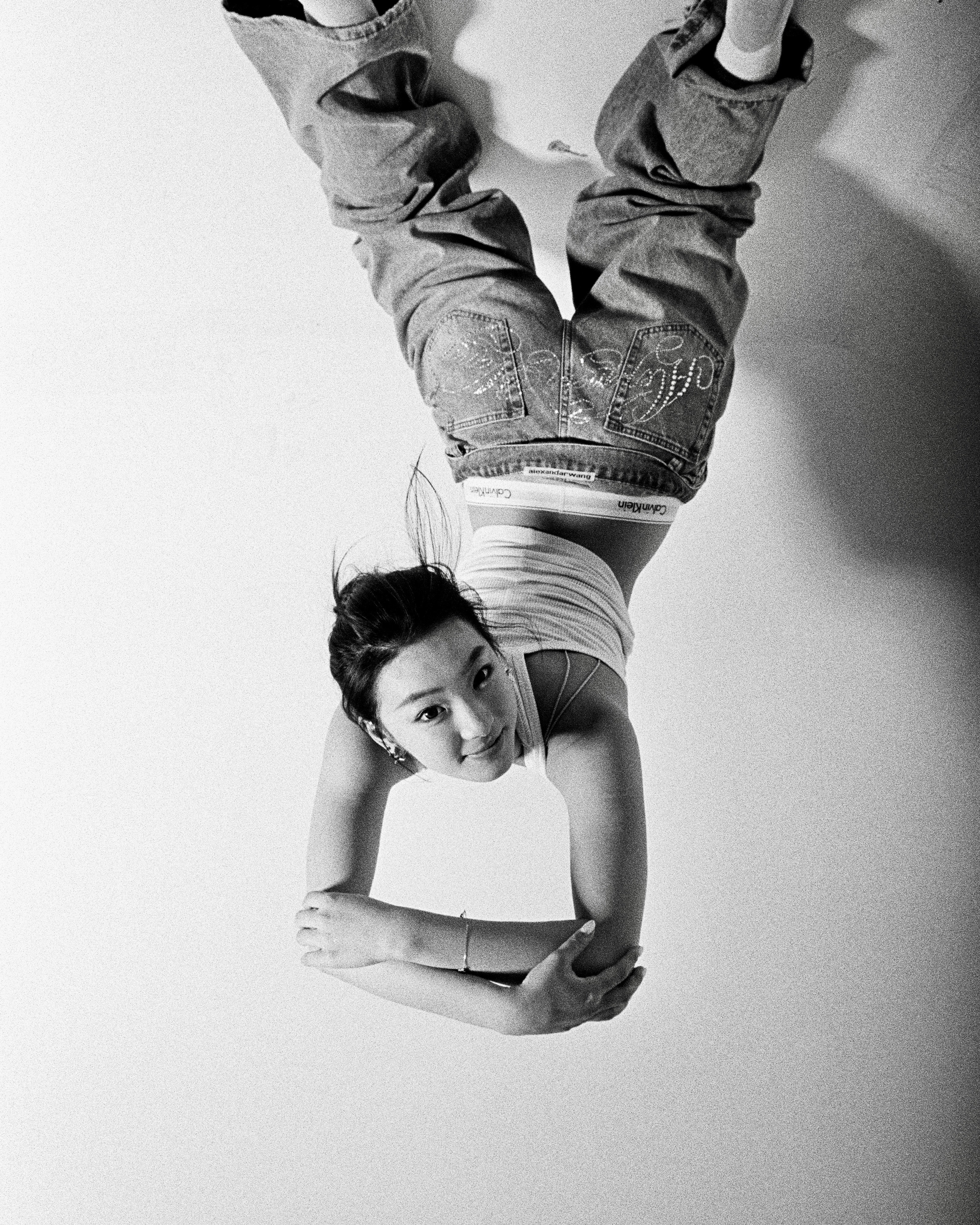 Nikon F4，Nikkor Ais 50mm/f2，Kodak T-max 4oo | Woman in jeans does a handstand on white background