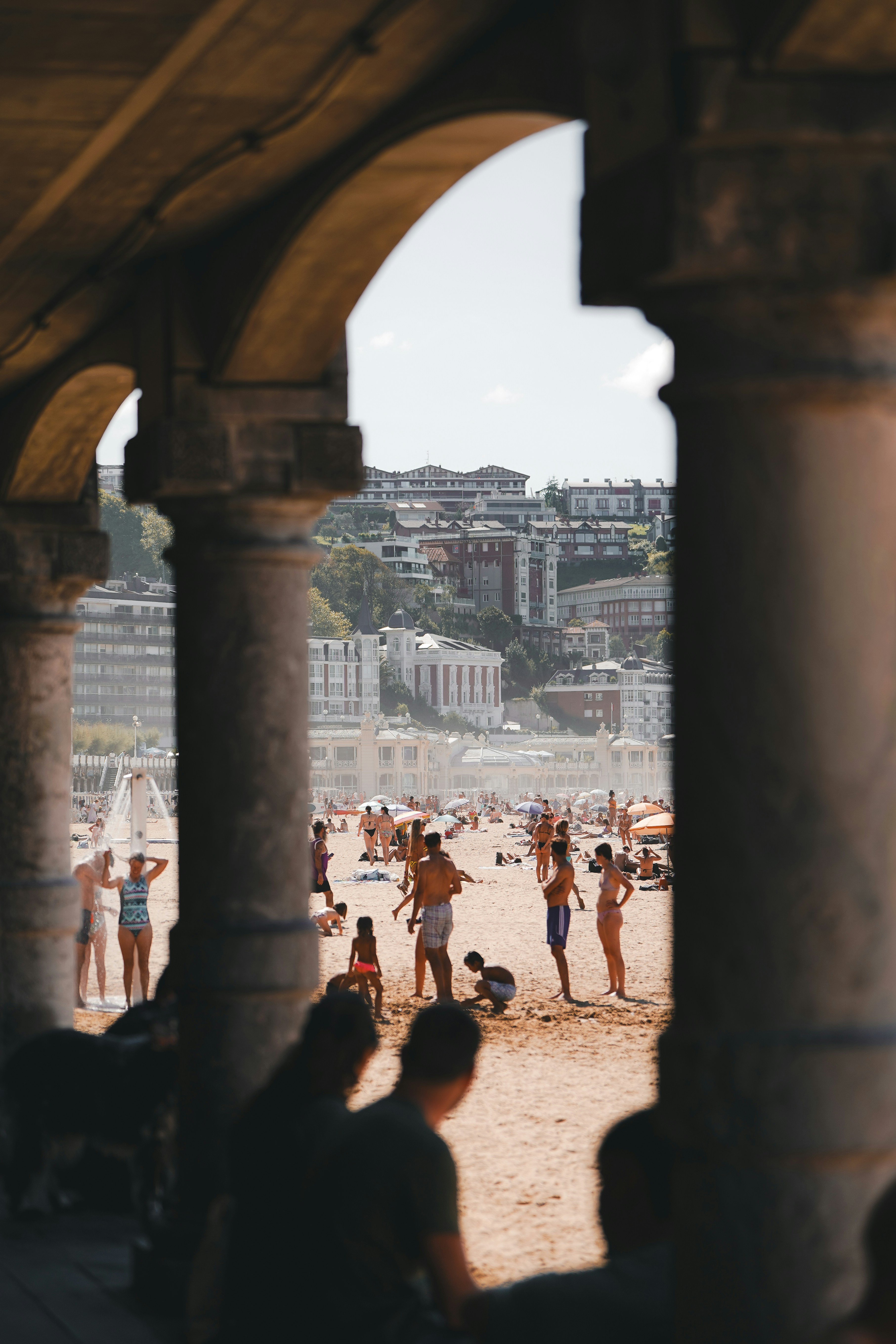 People enjoying a sunny day at a crowded beach.