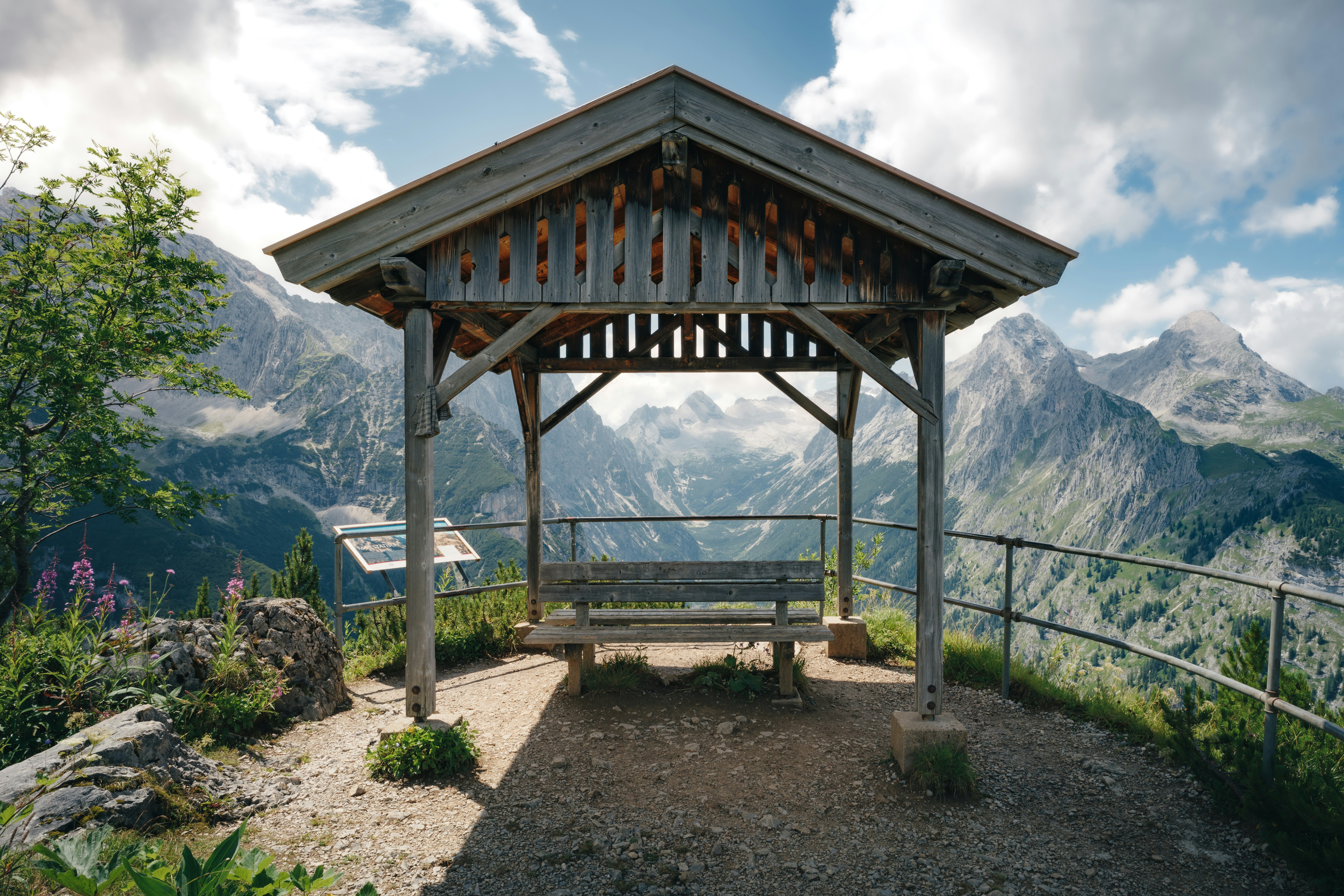 Wooden gazebo with bench overlooking mountain landscape
