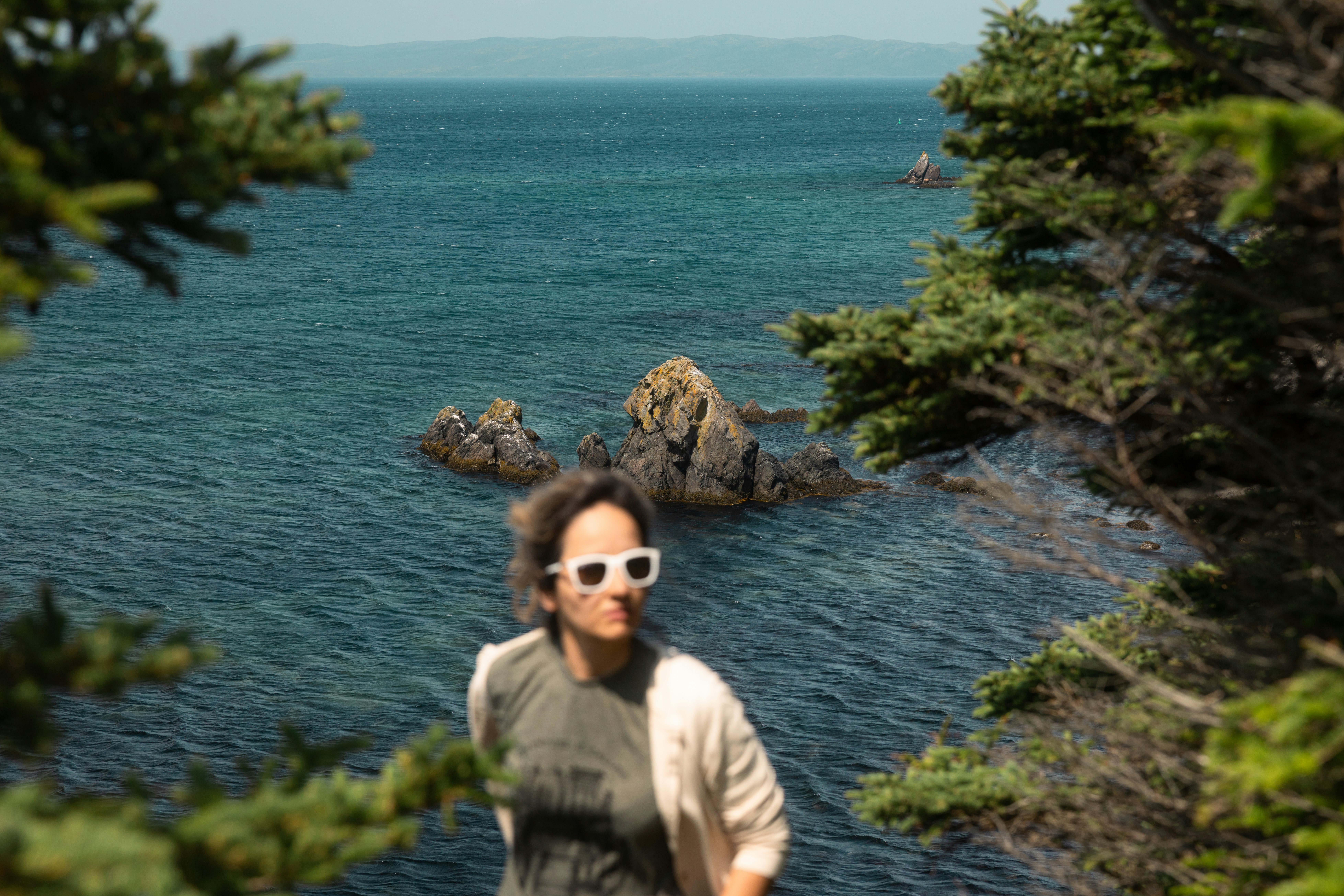 Woman with sunglasses by the ocean