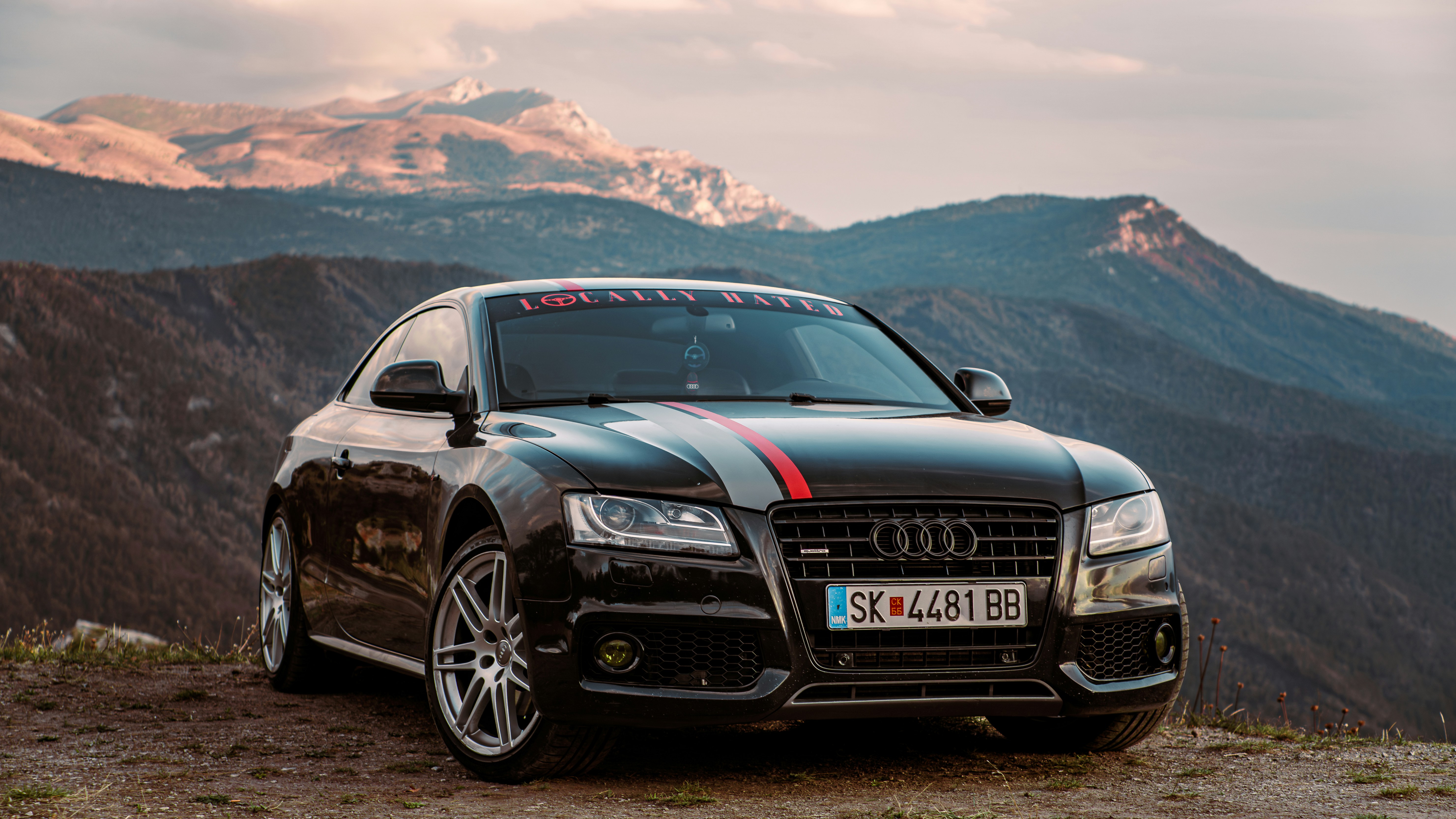 Black audi parked on a mountain overlook.
