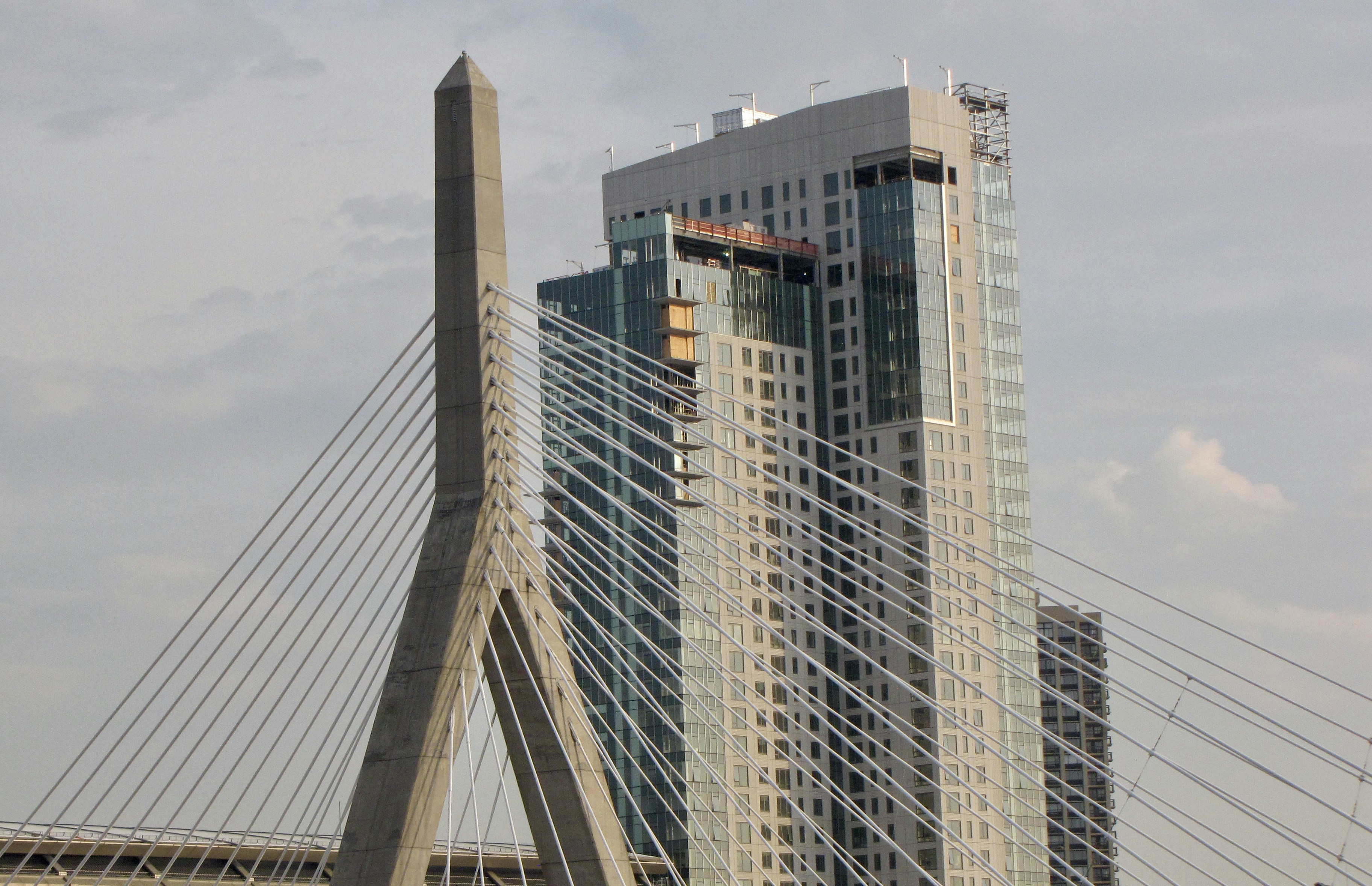 Modern suspension bridge tower and skyscrapers