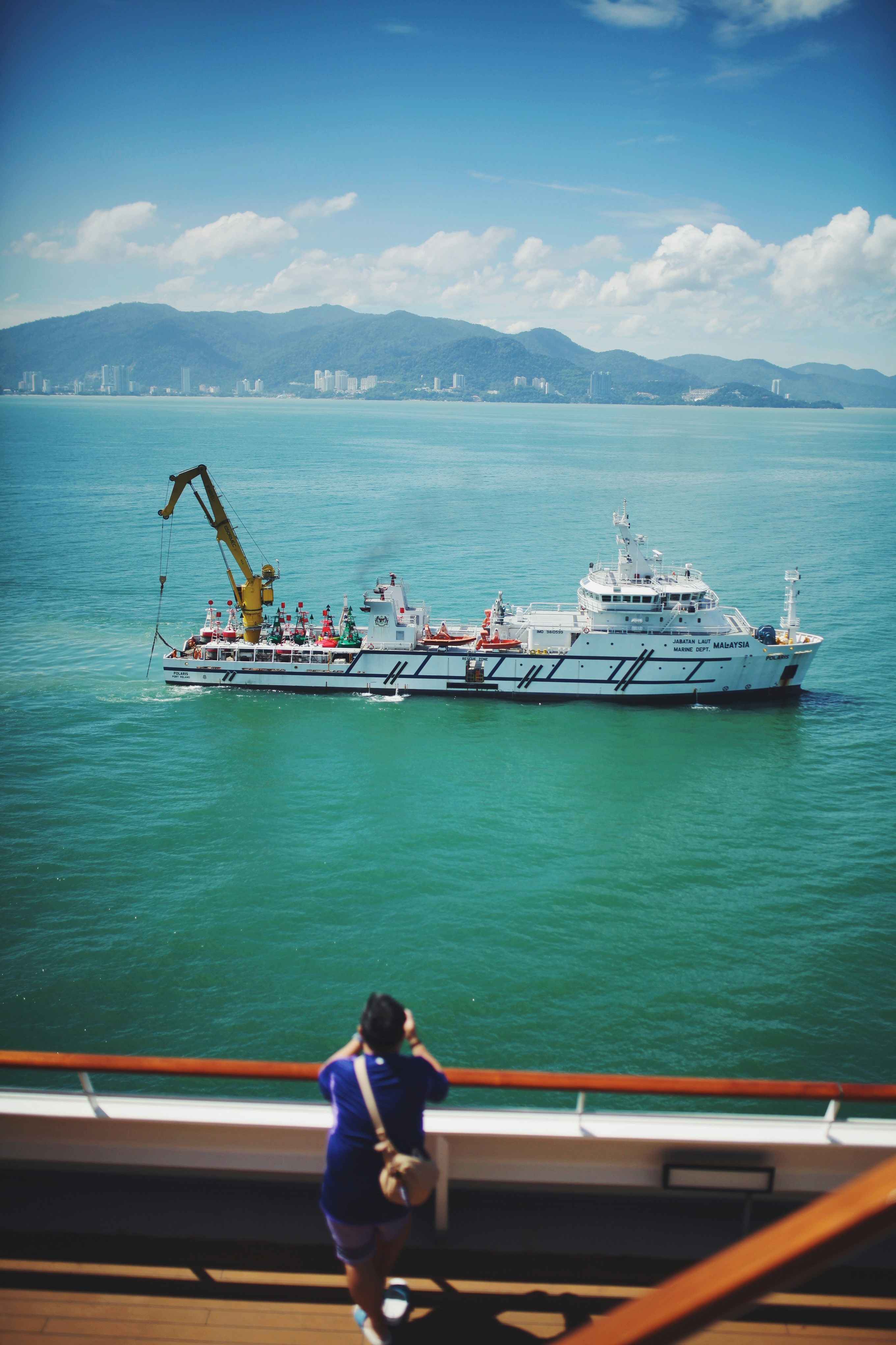 Costa Serena cruise ship | Person watches research ship on the ocean.