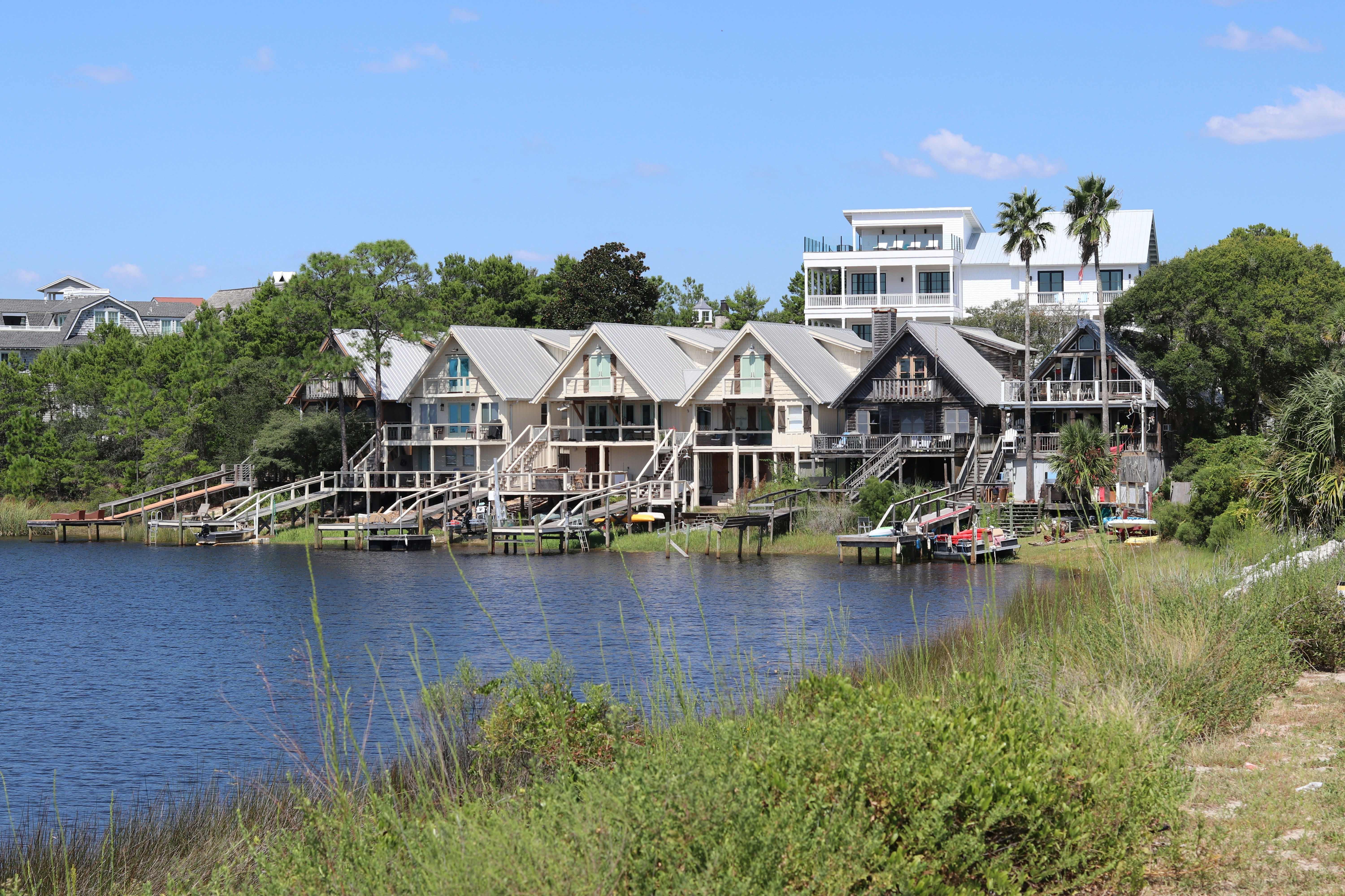 Waterfront houses with wooden docks and boats.