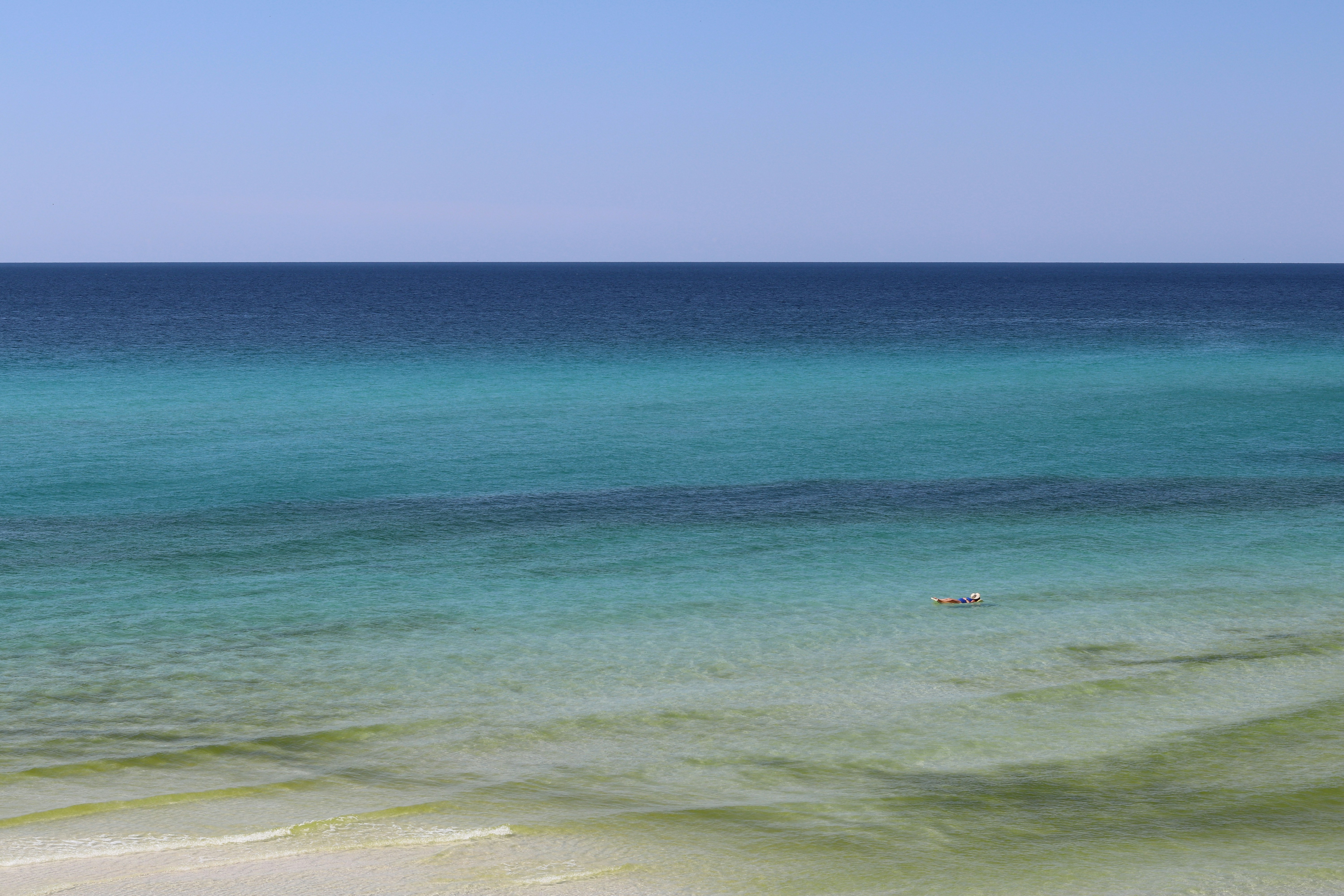 Clear turquoise ocean water with a distant horizon.