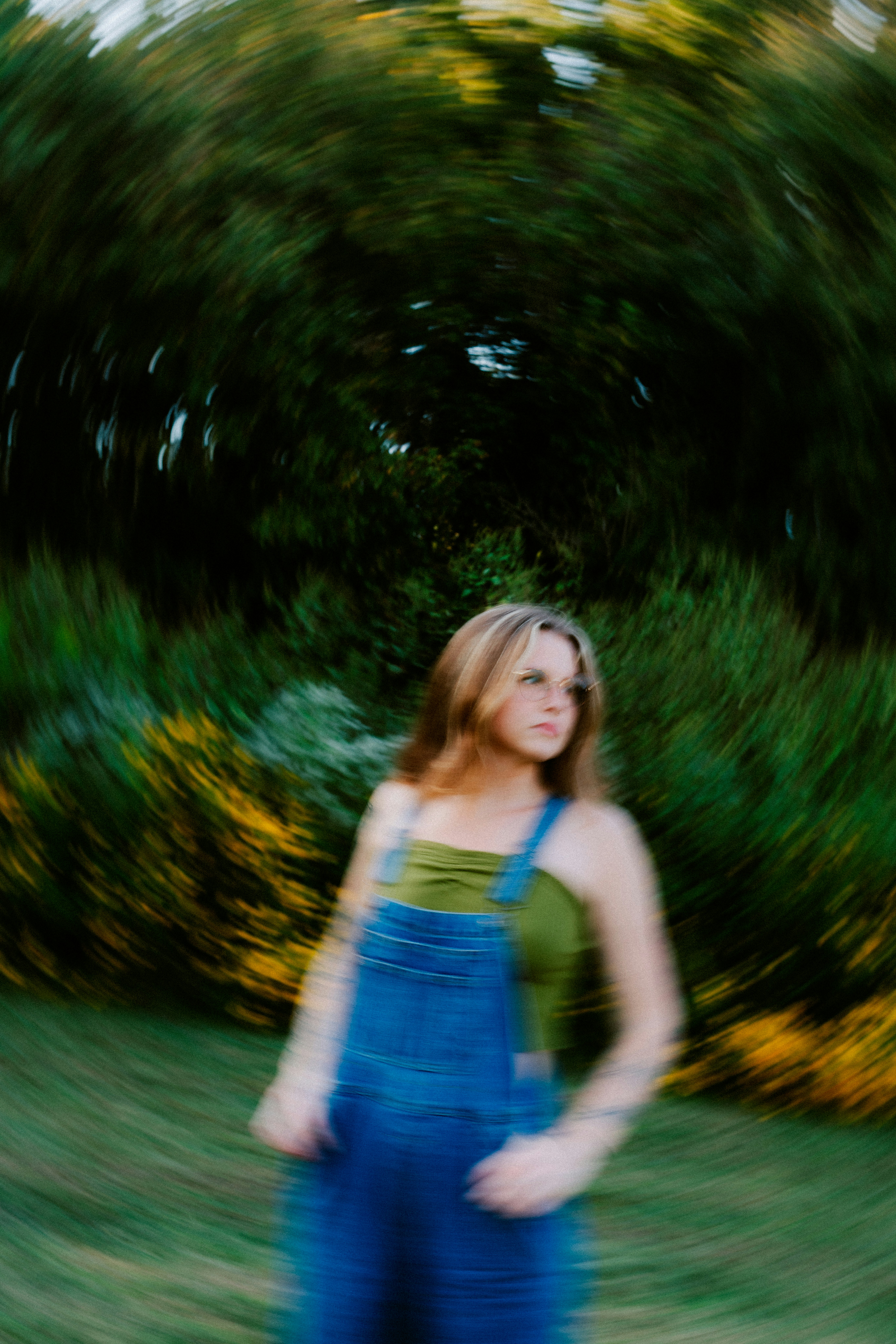 Young woman in overalls with blurred motion effect