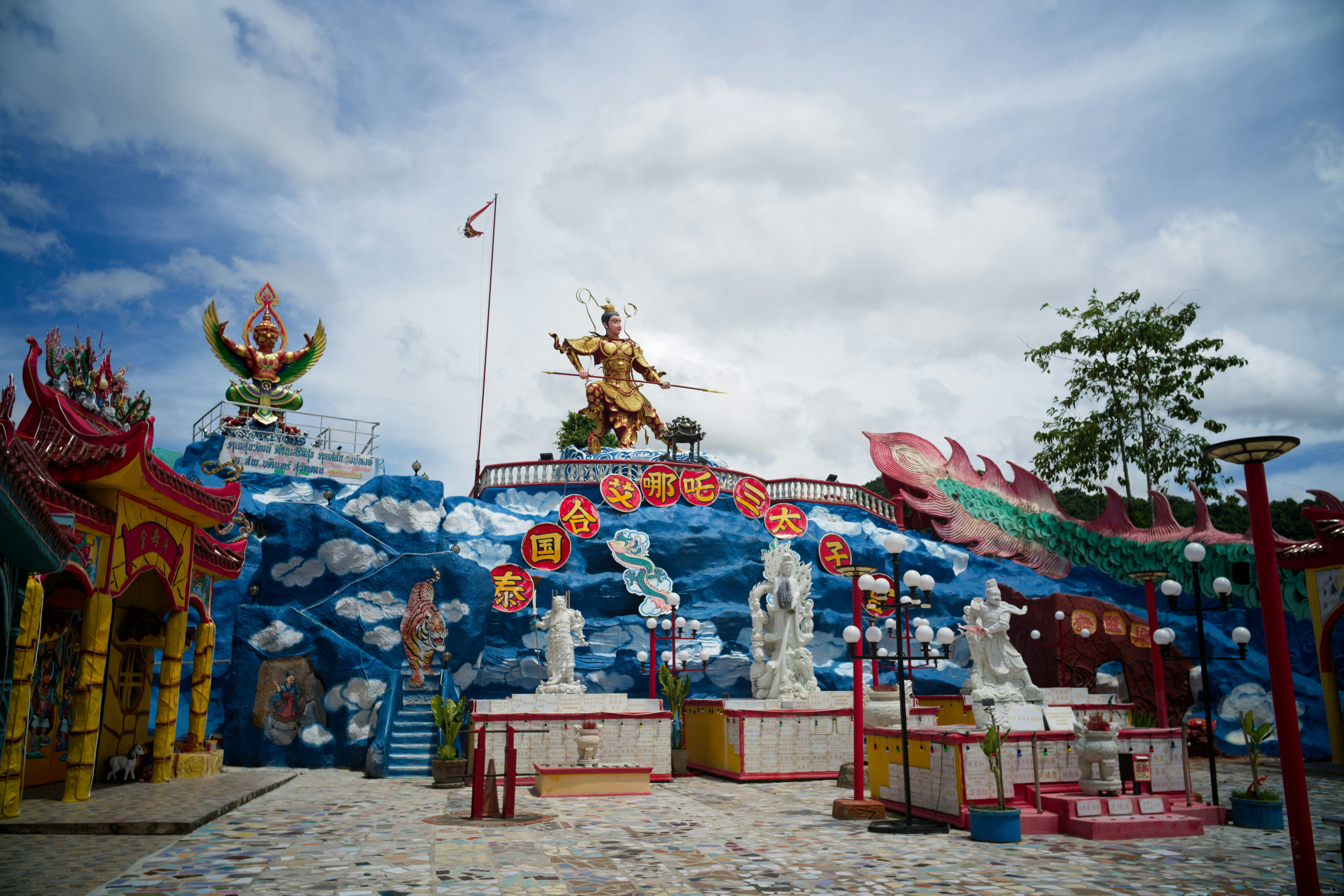 Golden Sentinel on a Dragon-Arch Terrace Amid Colorful Shrine Sculptures