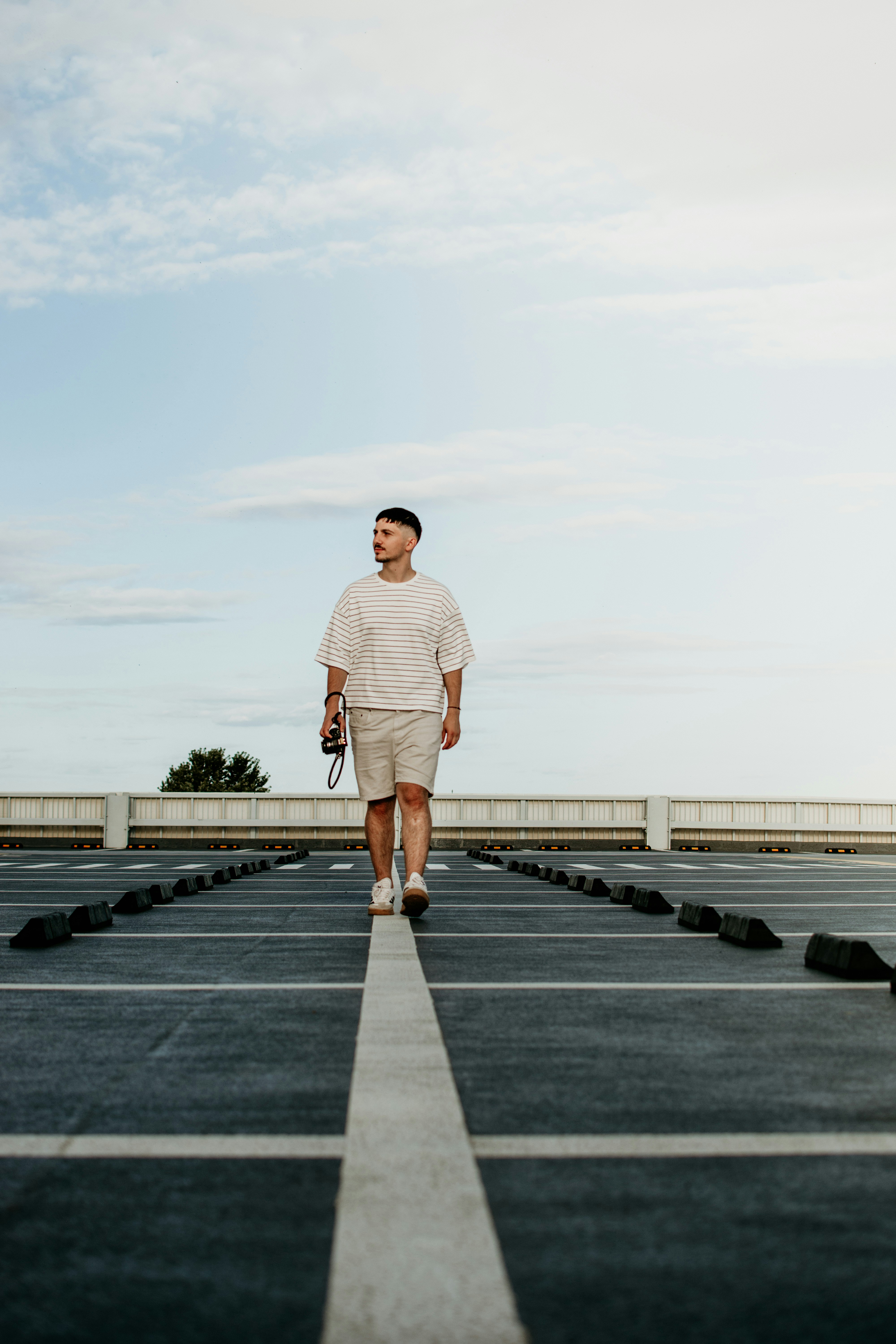 Centerline Gaze: A Solo Figure Walks the White Divide on an Empty Rooftop