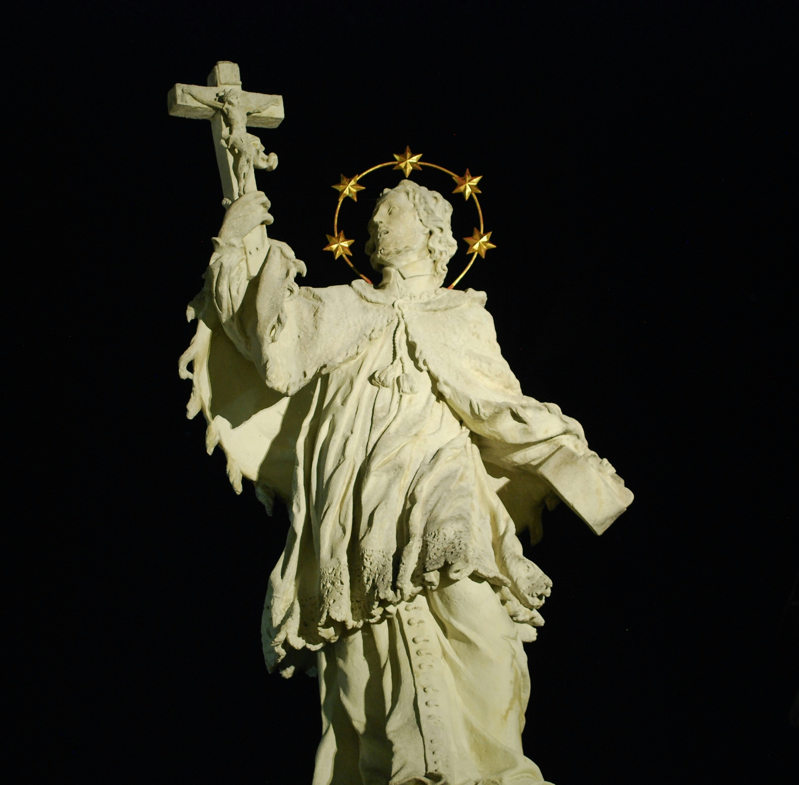 Statue of a saint holding a cross with halo
