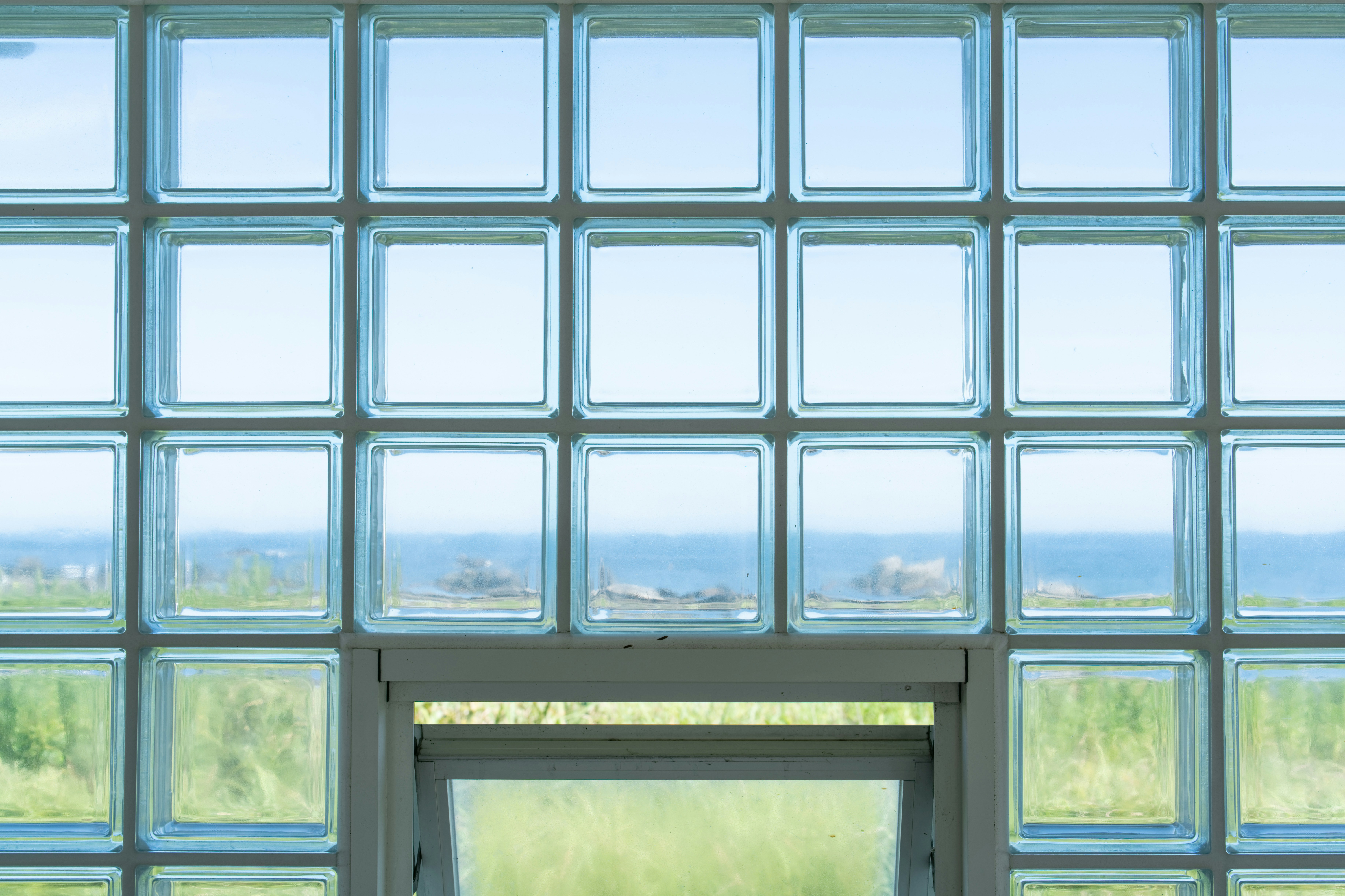 Framed Horizon: Seascape Through Glass Block Windows