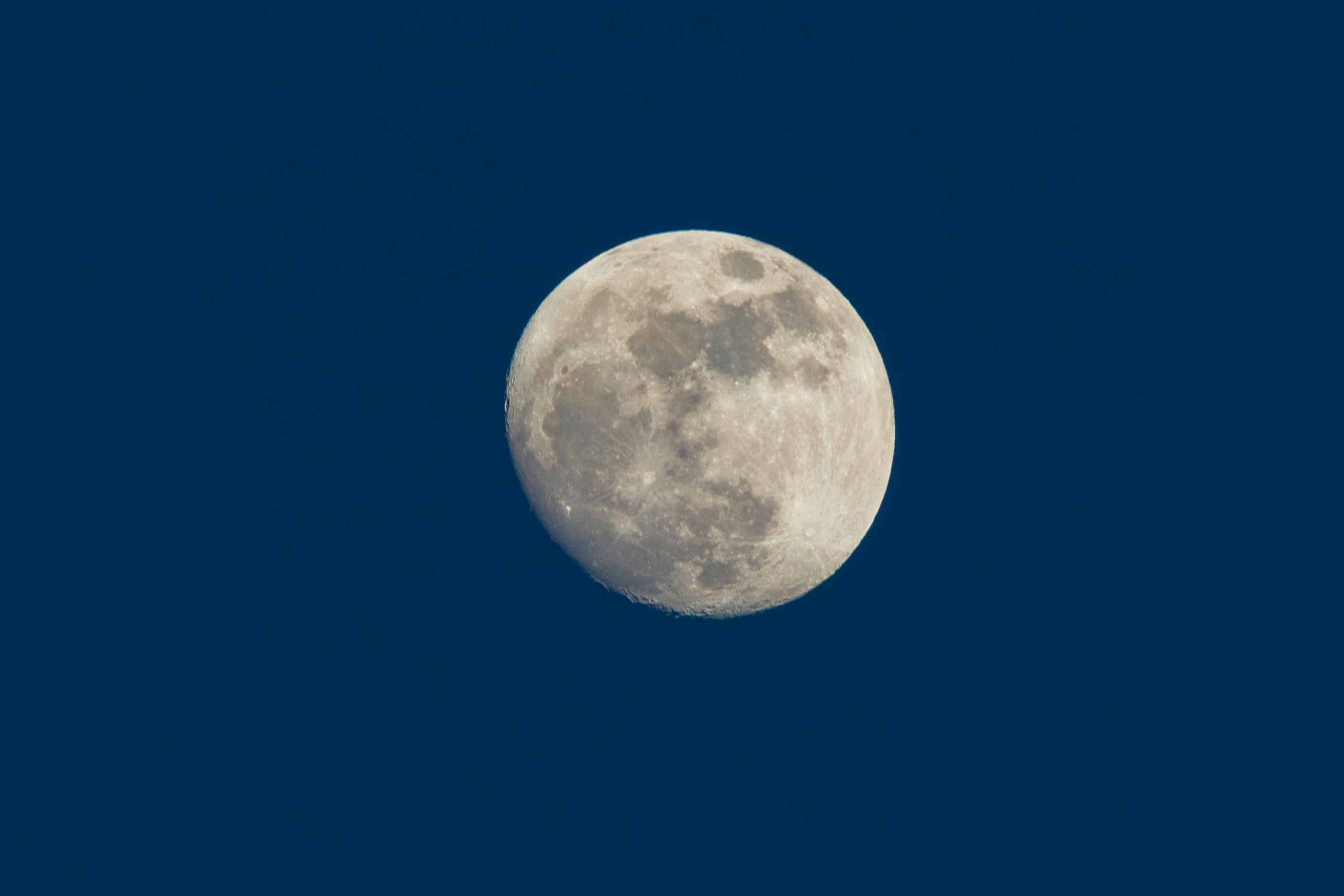Full moon against a dark blue sky