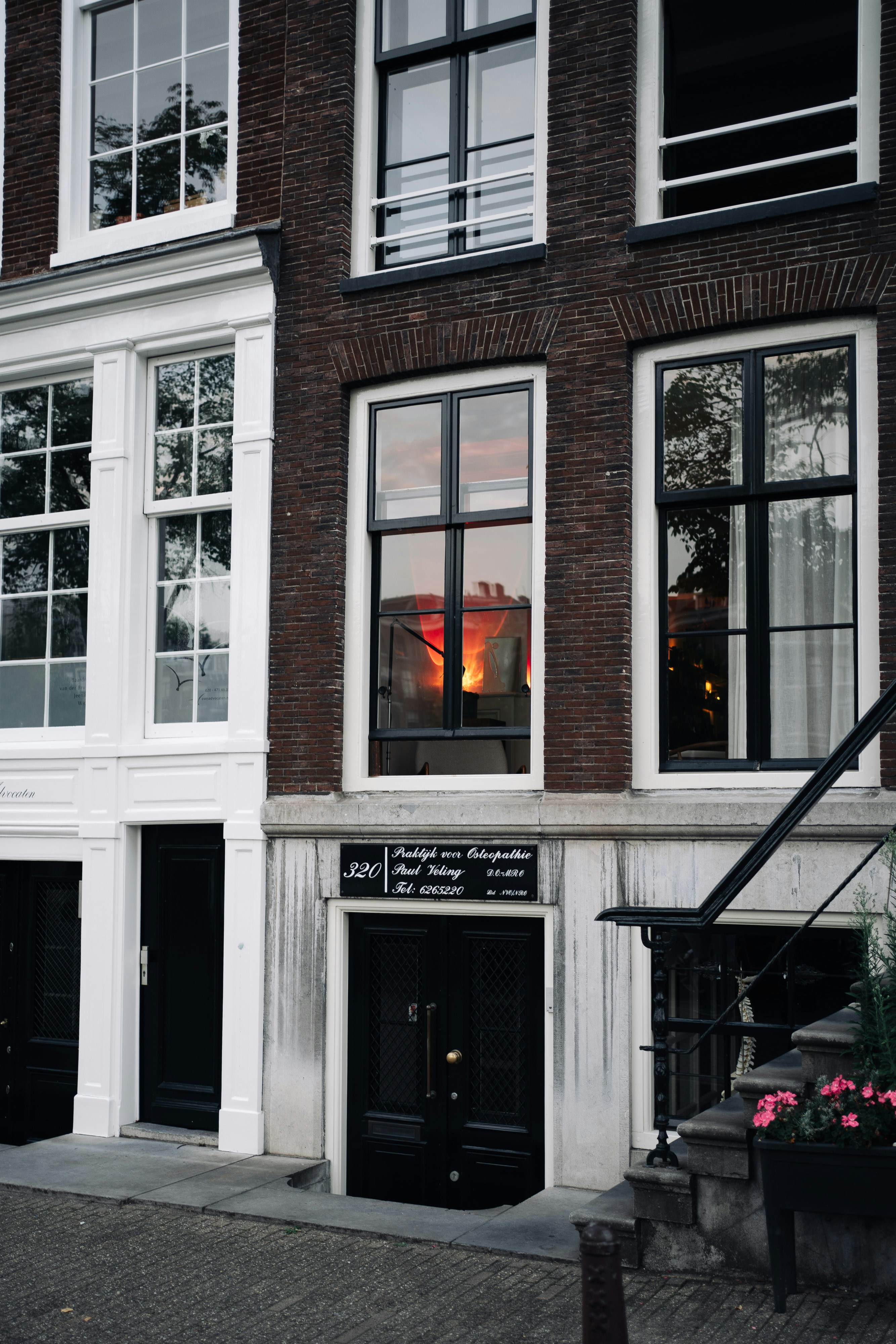 Sunset reflected in window of brick building