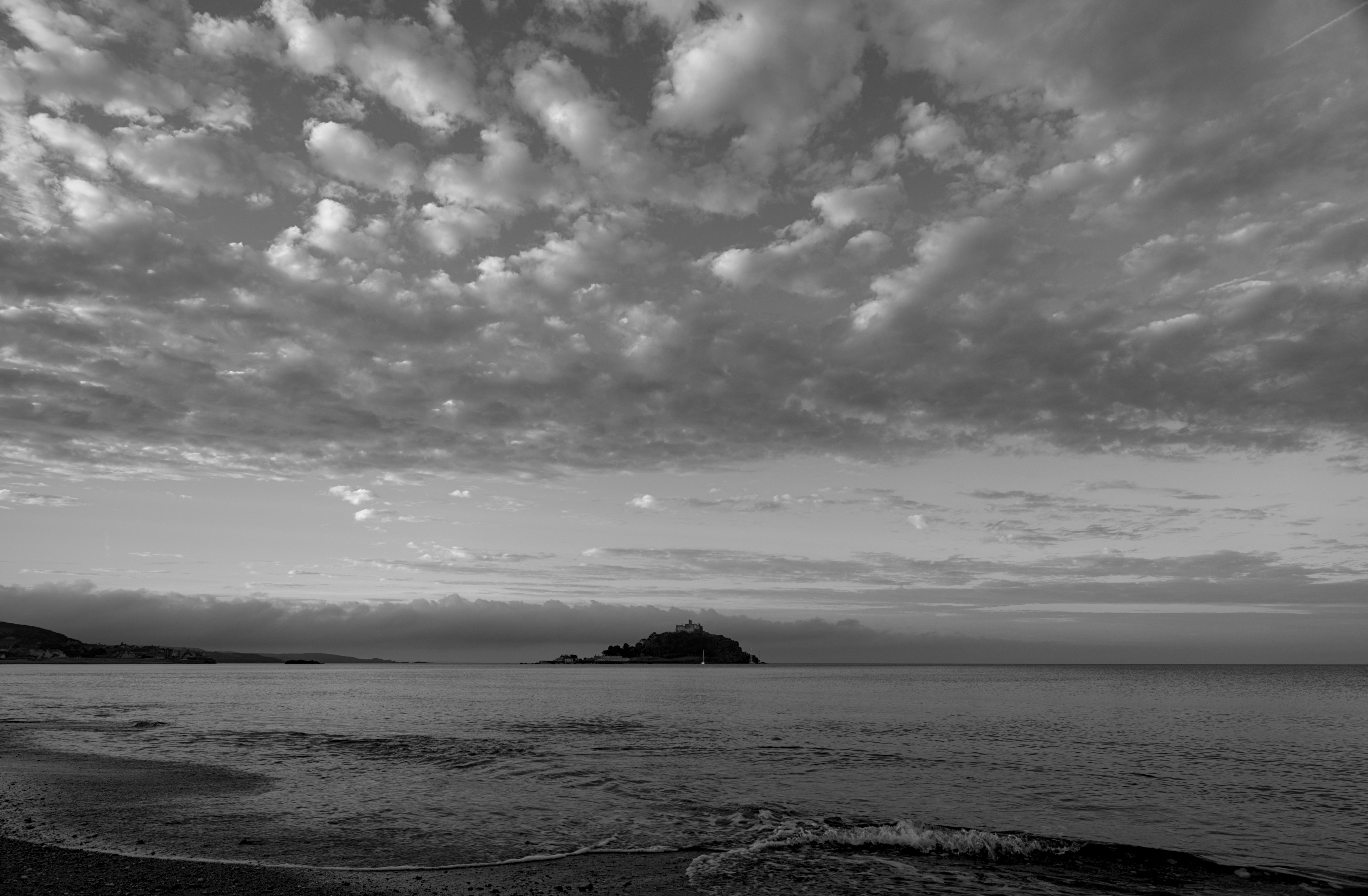 Dramatic clouds over a calm ocean at dusk