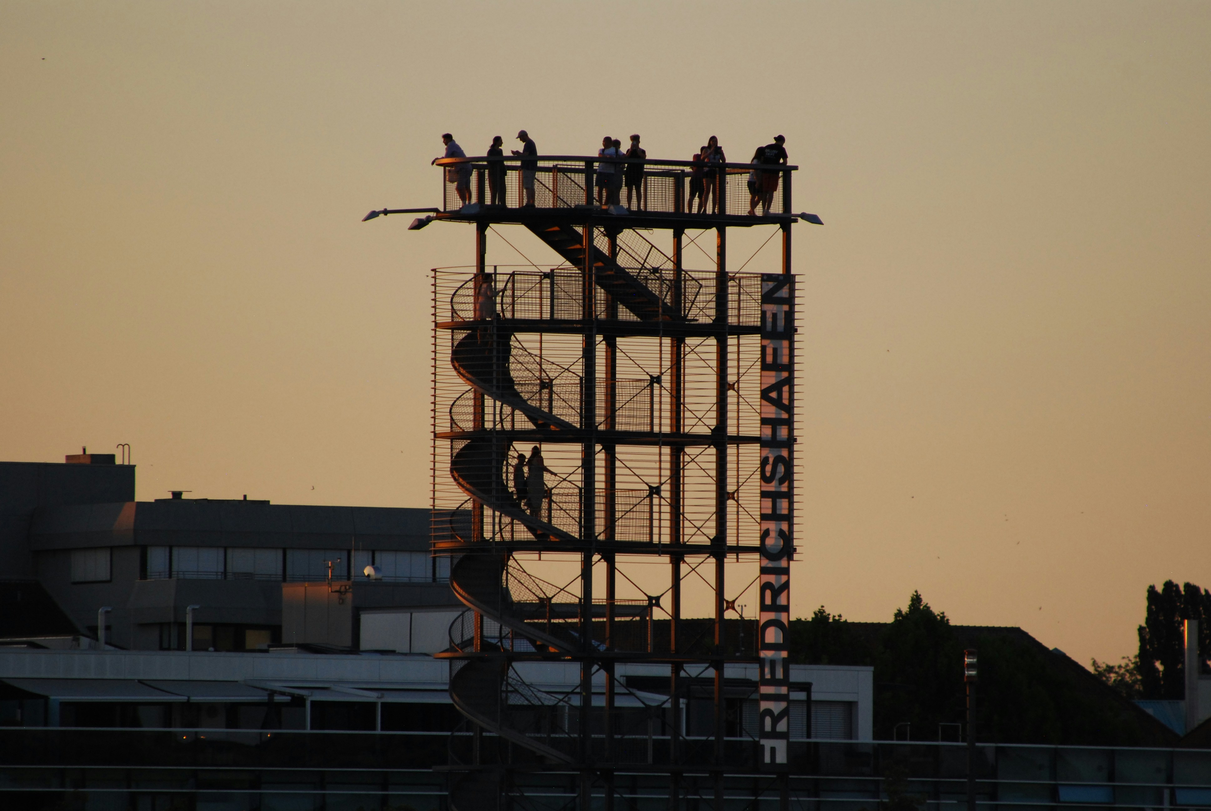 Last Light on the Spiral Tower: silhouettes atop the rooftop