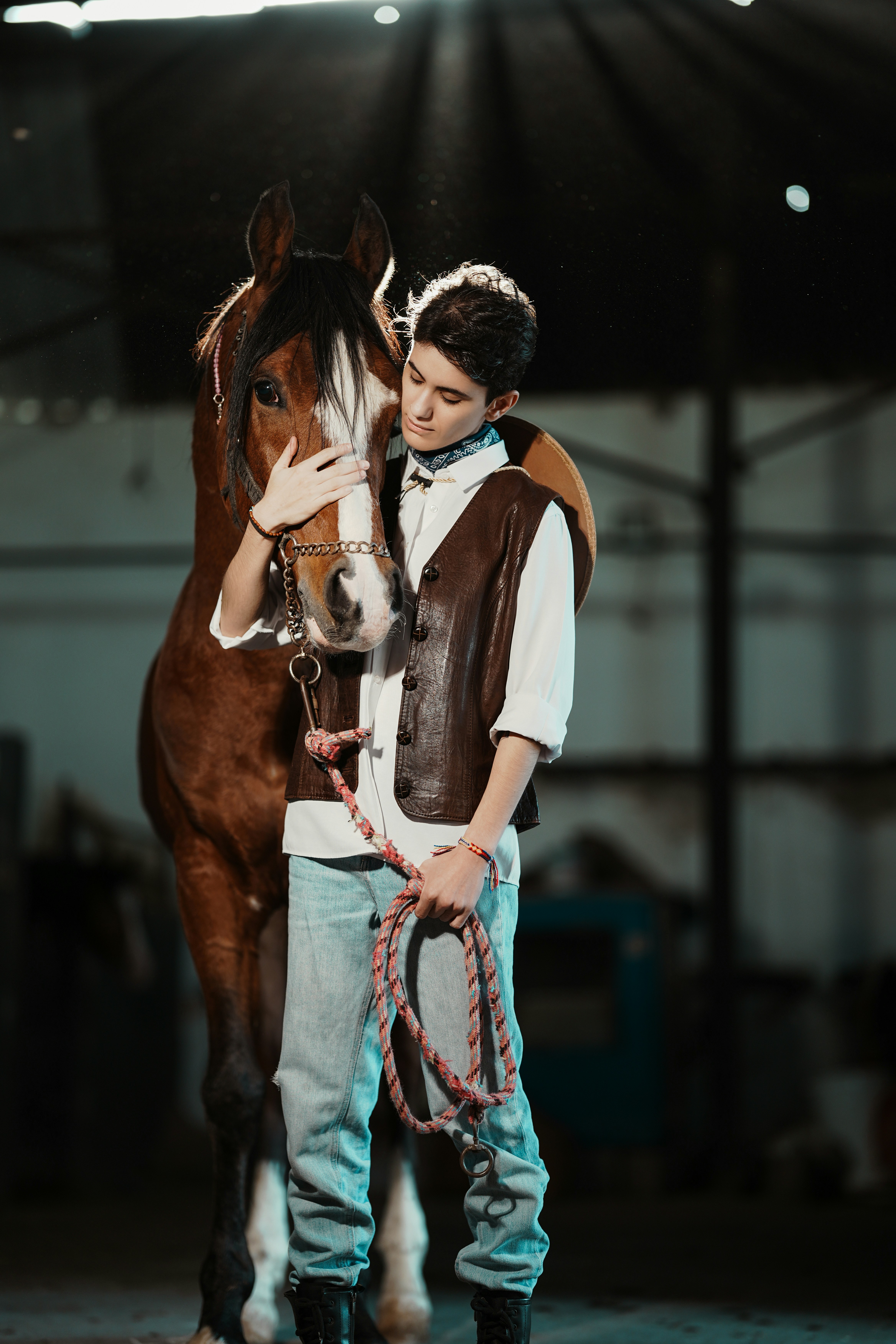 Quiet Bond: A Rider and his Horse Rest under Soft Stage Light