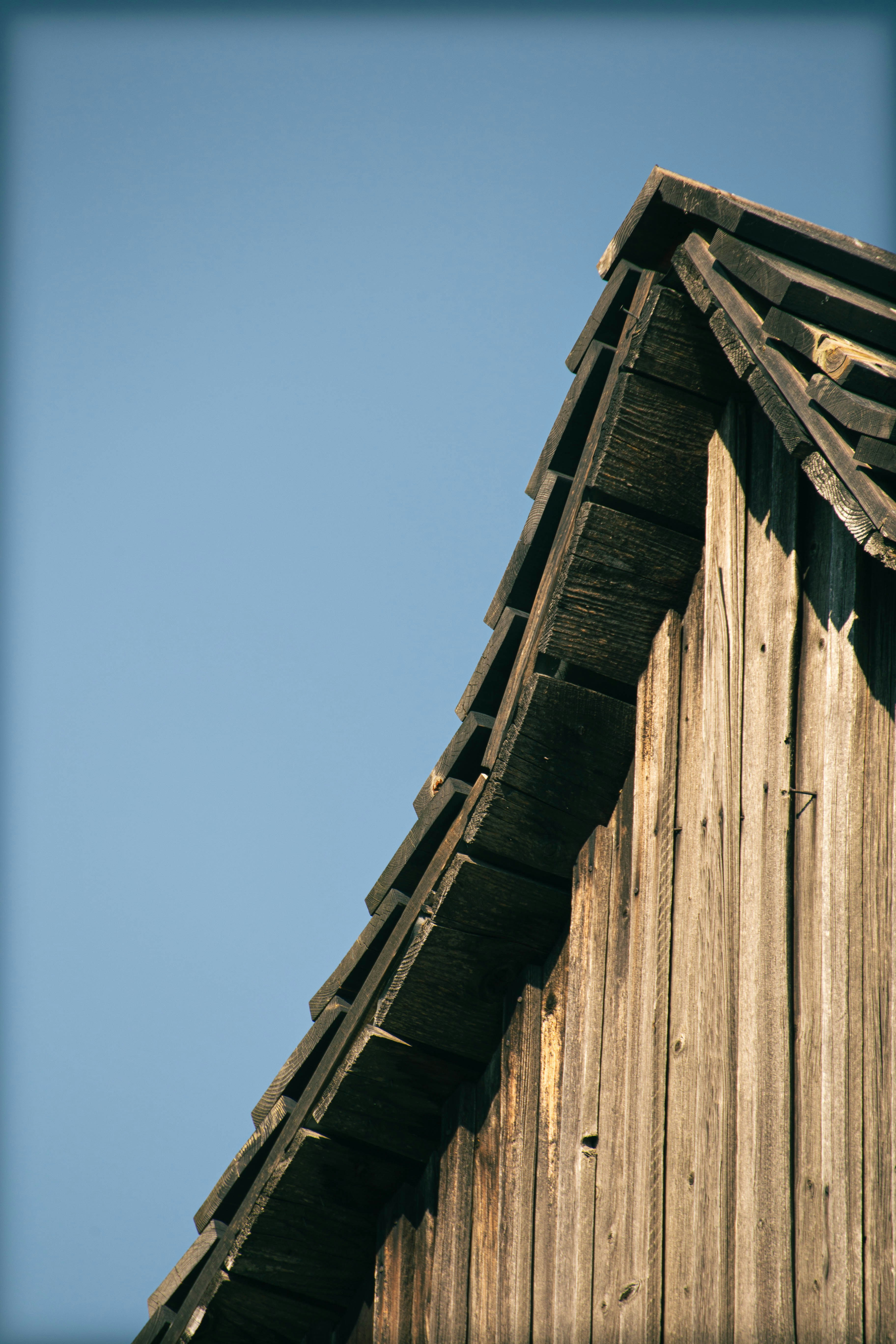 Close-up of weathered wooden building roof against sky