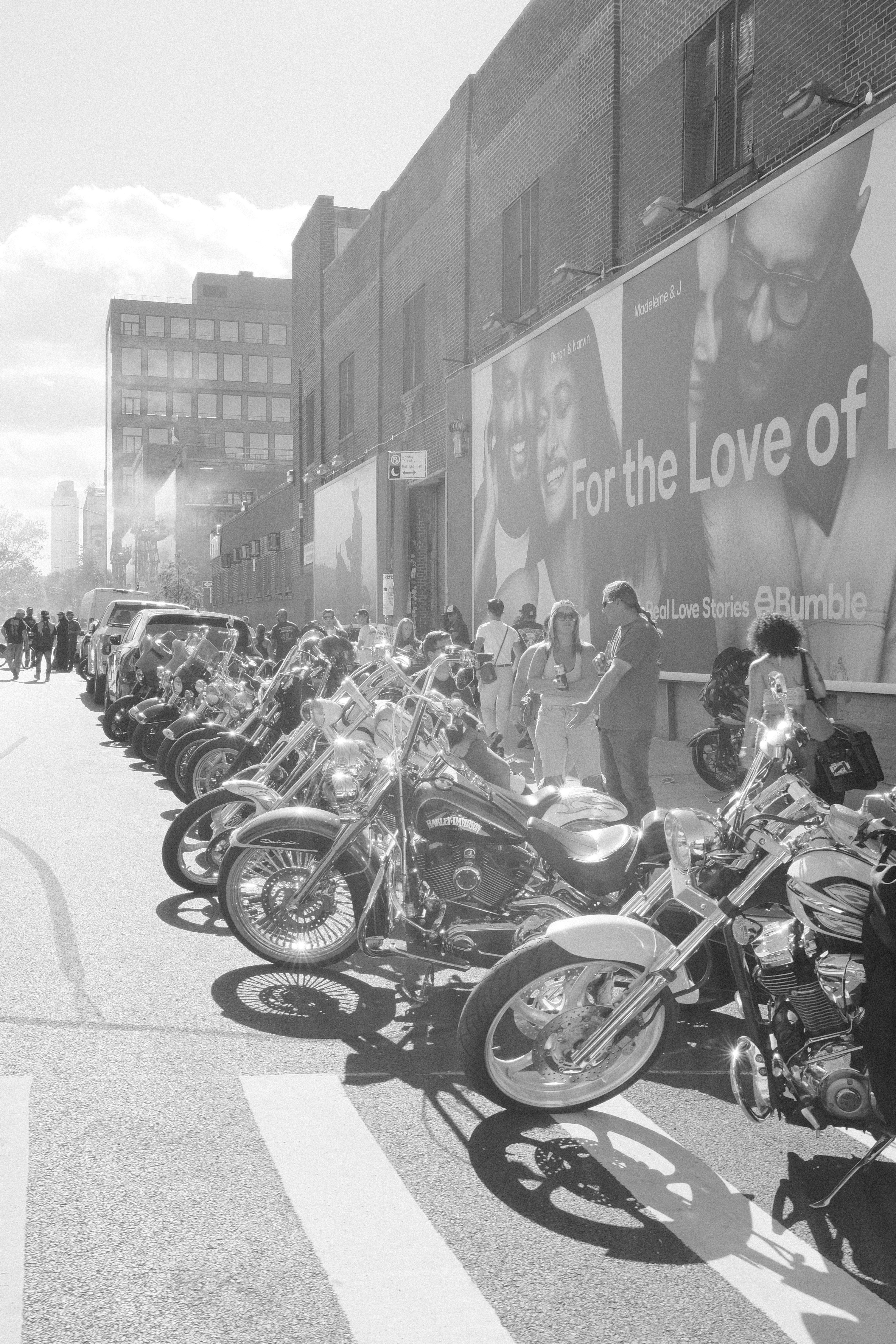 Chrome Row on a Sunlit Street: Motorcycles Aligned by a City Billboard