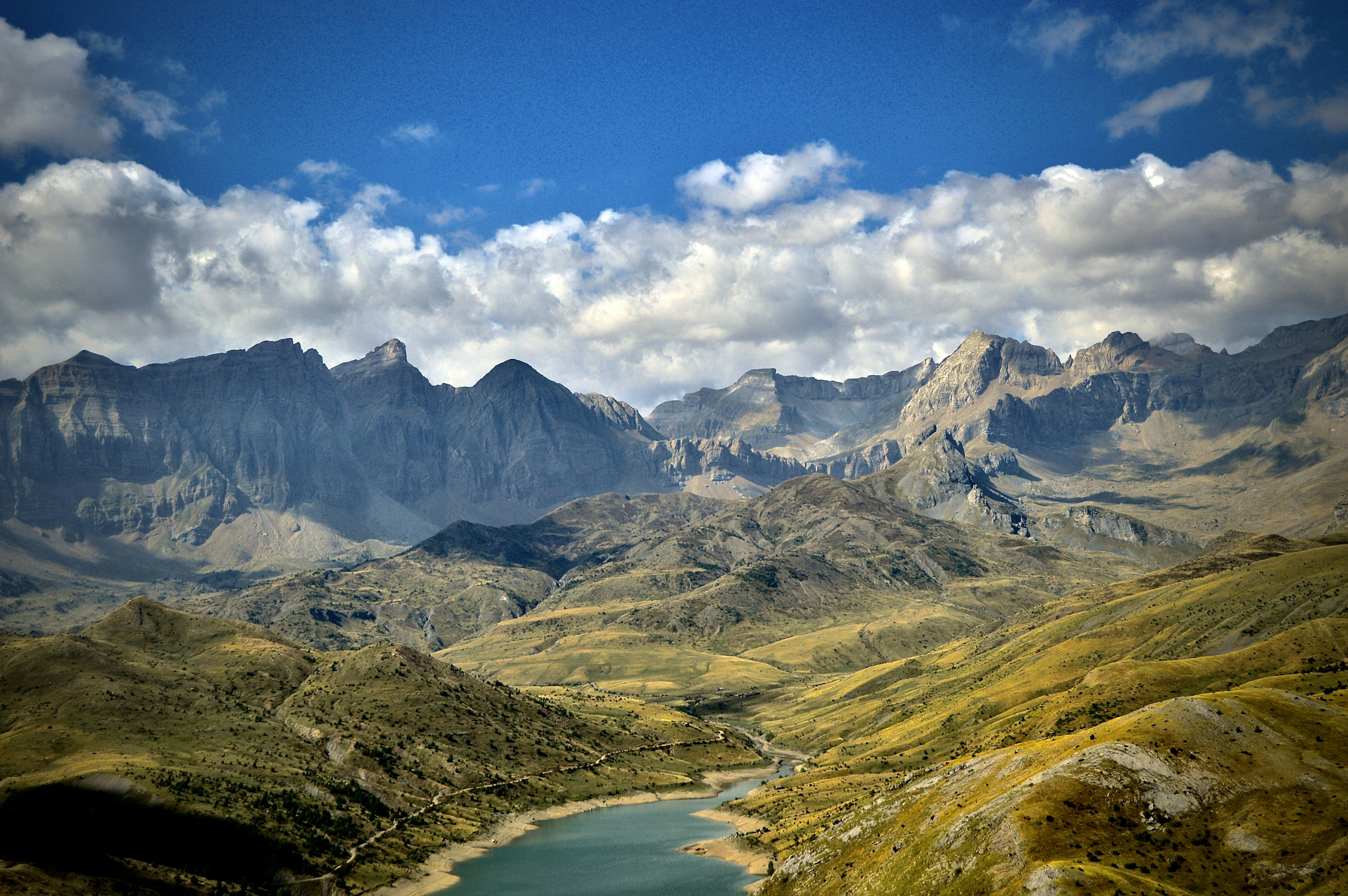 Mountain range with a lake under a cloudy sky