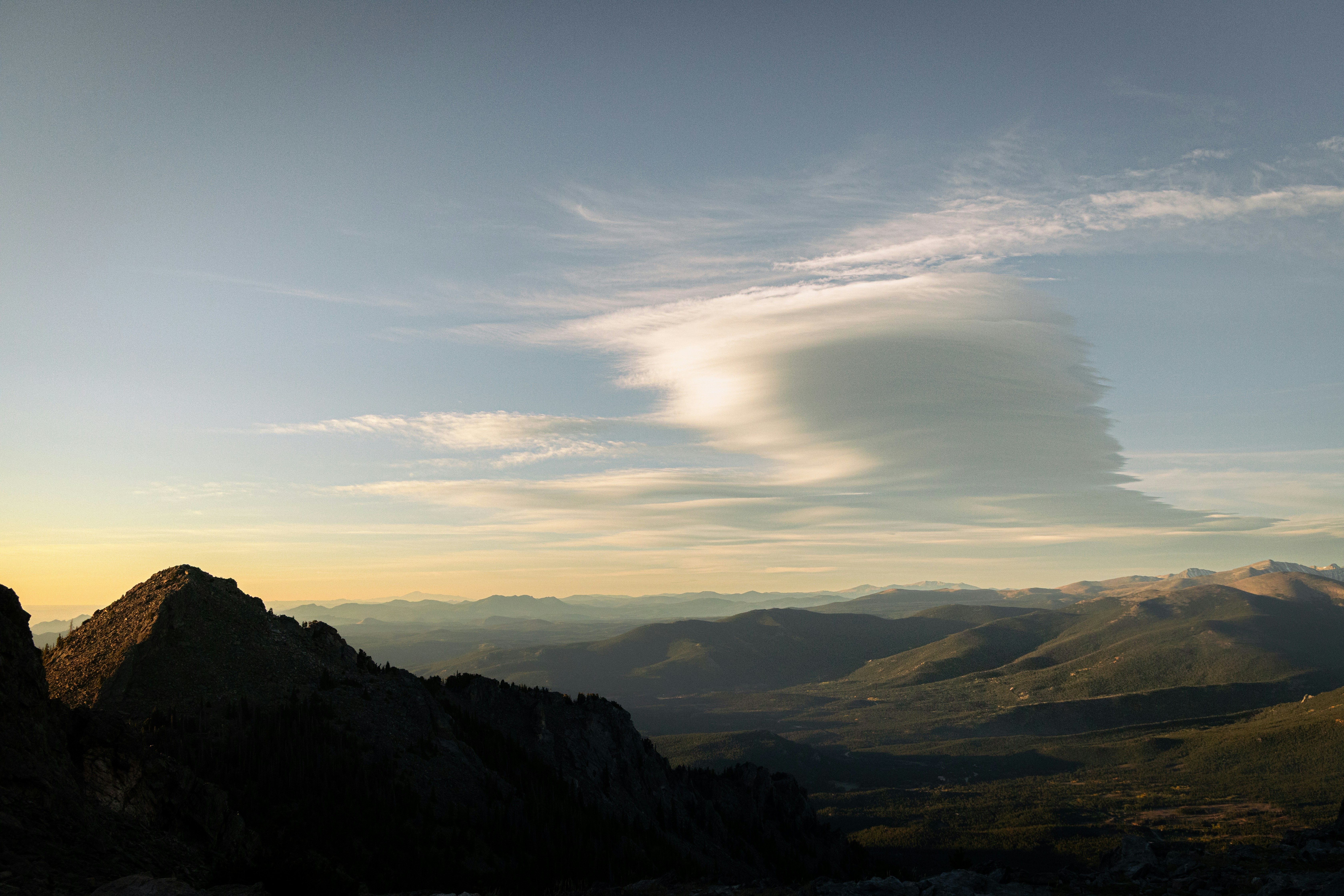 Mountain landscape with dramatic lenticular cloud formation.