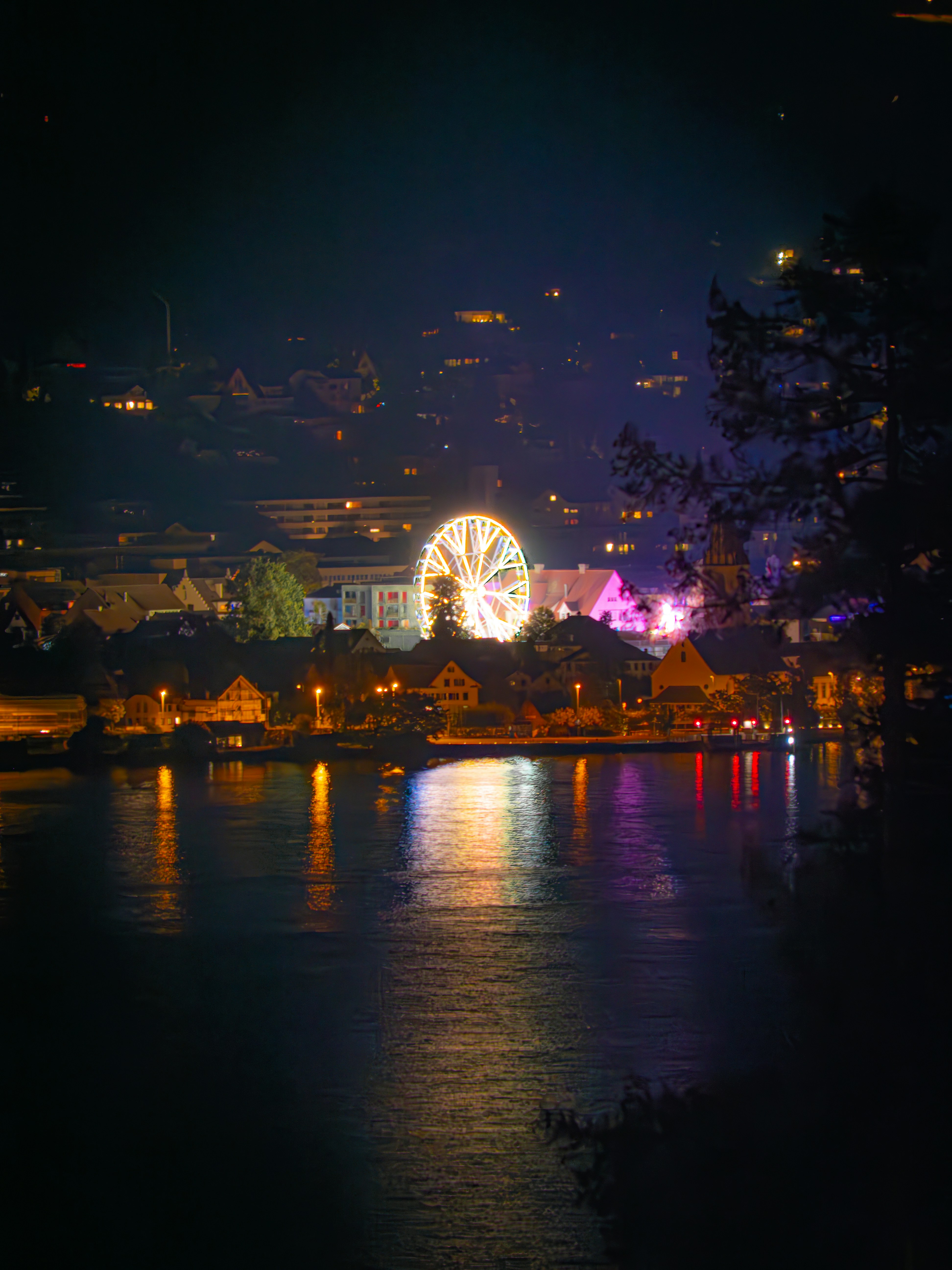 Ferris Wheel Glow Over a Quiet Riverfront Town